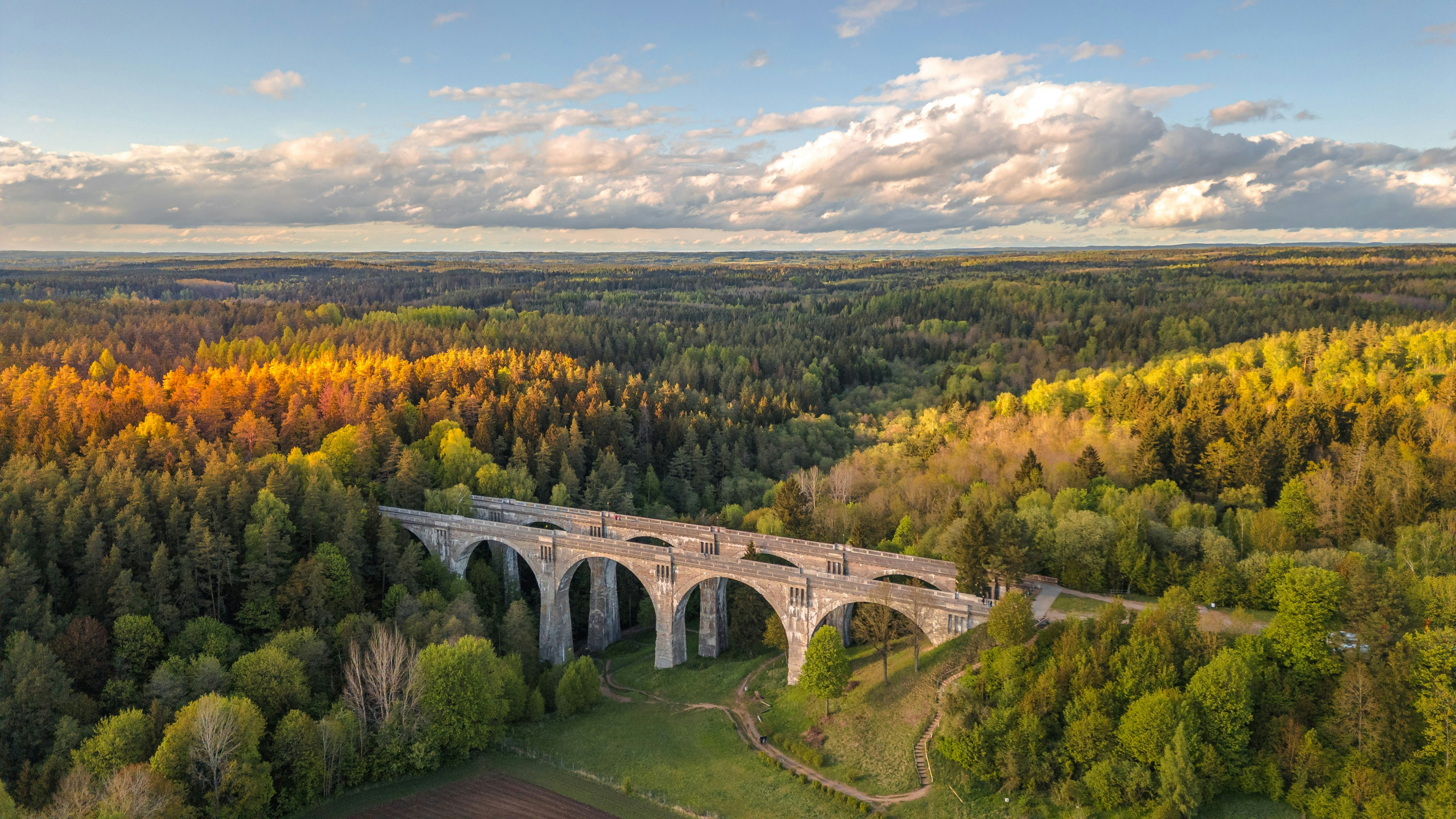 Autumn Arc: A Stone Viaduct Crossing a River Valley