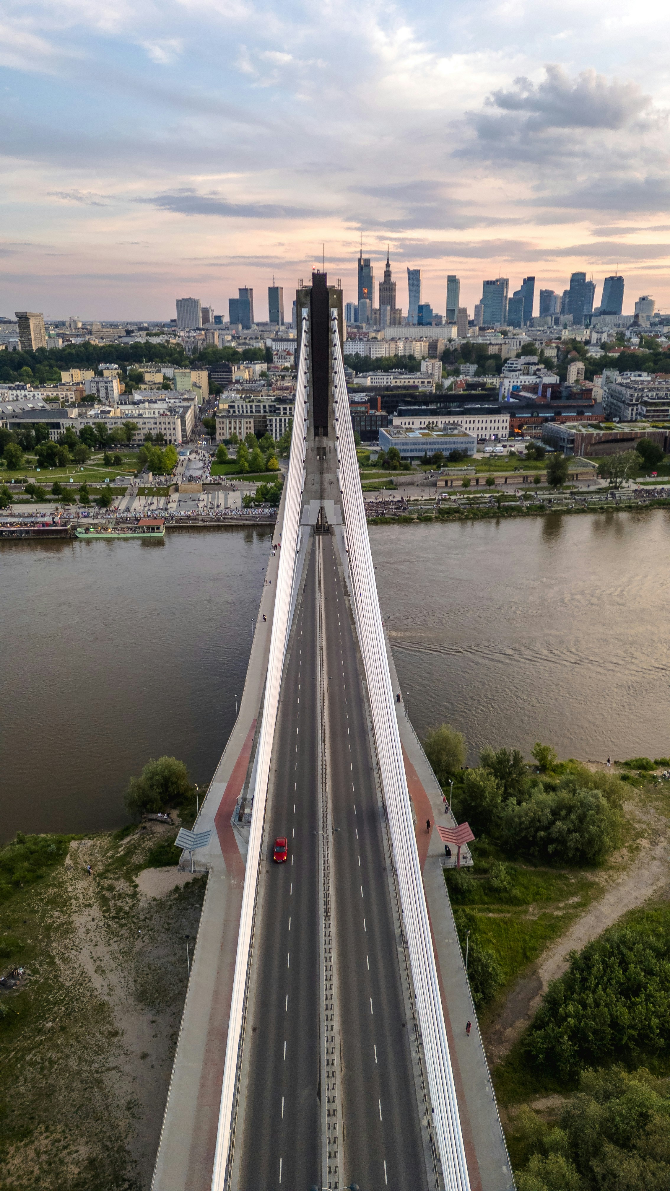 Vertical Crossing: Aerial View of a Modern Bridge Reaching Toward a Distant Skyline