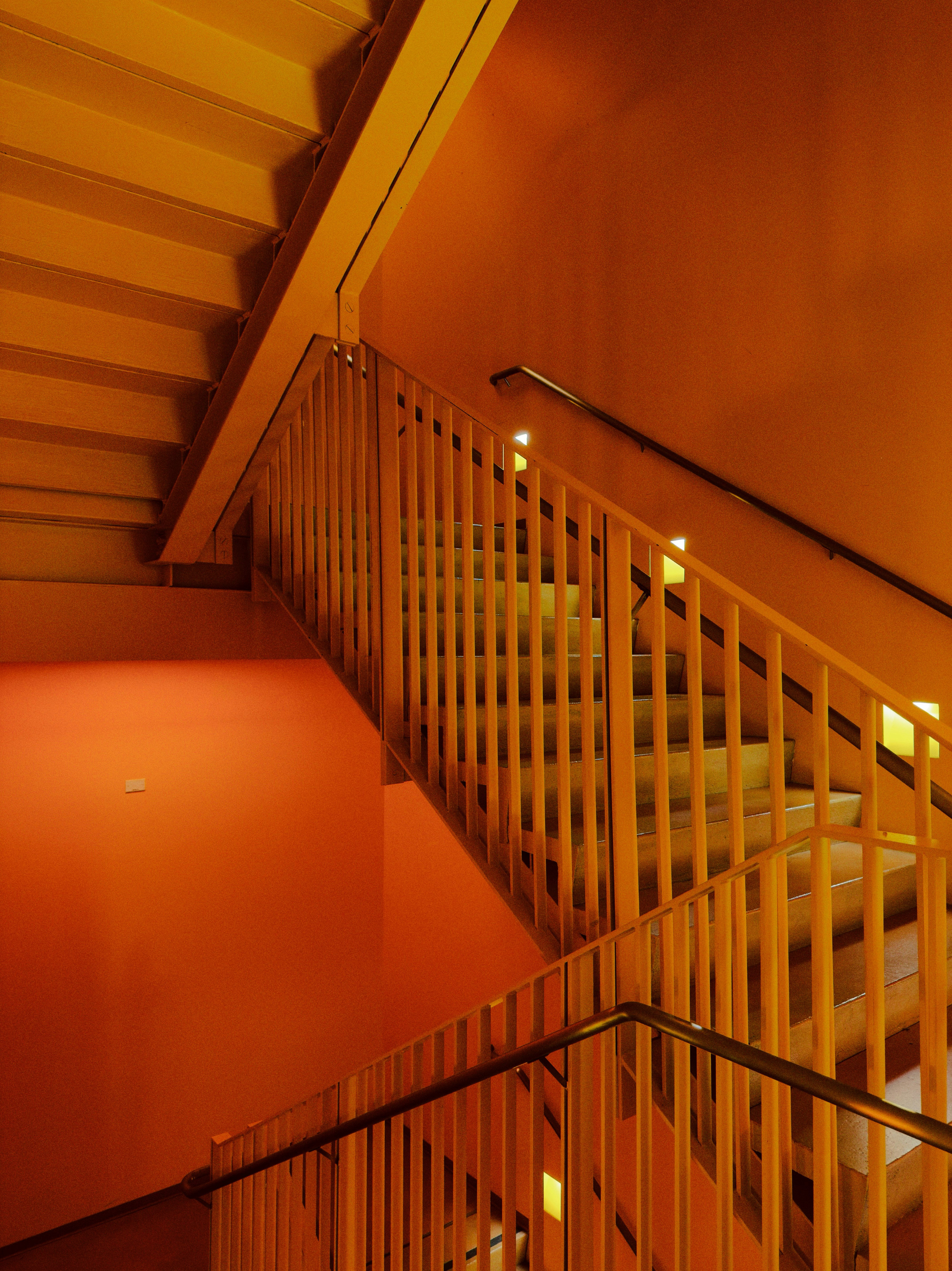 Orange Stairwell: Geometric Ribbons of Light and Shadow