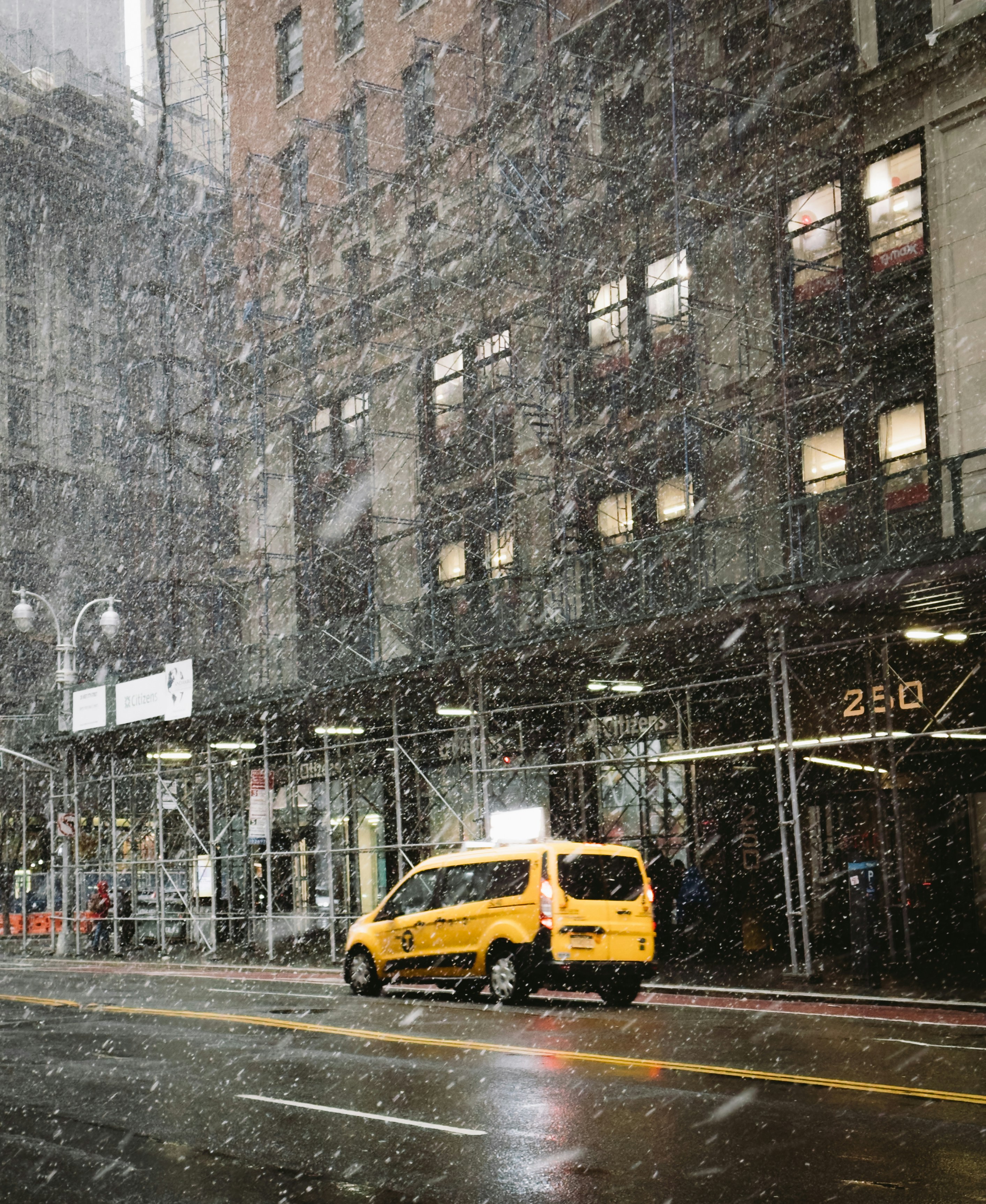 Yellow Cab in Snowfall: A City Street Painted with White Veil