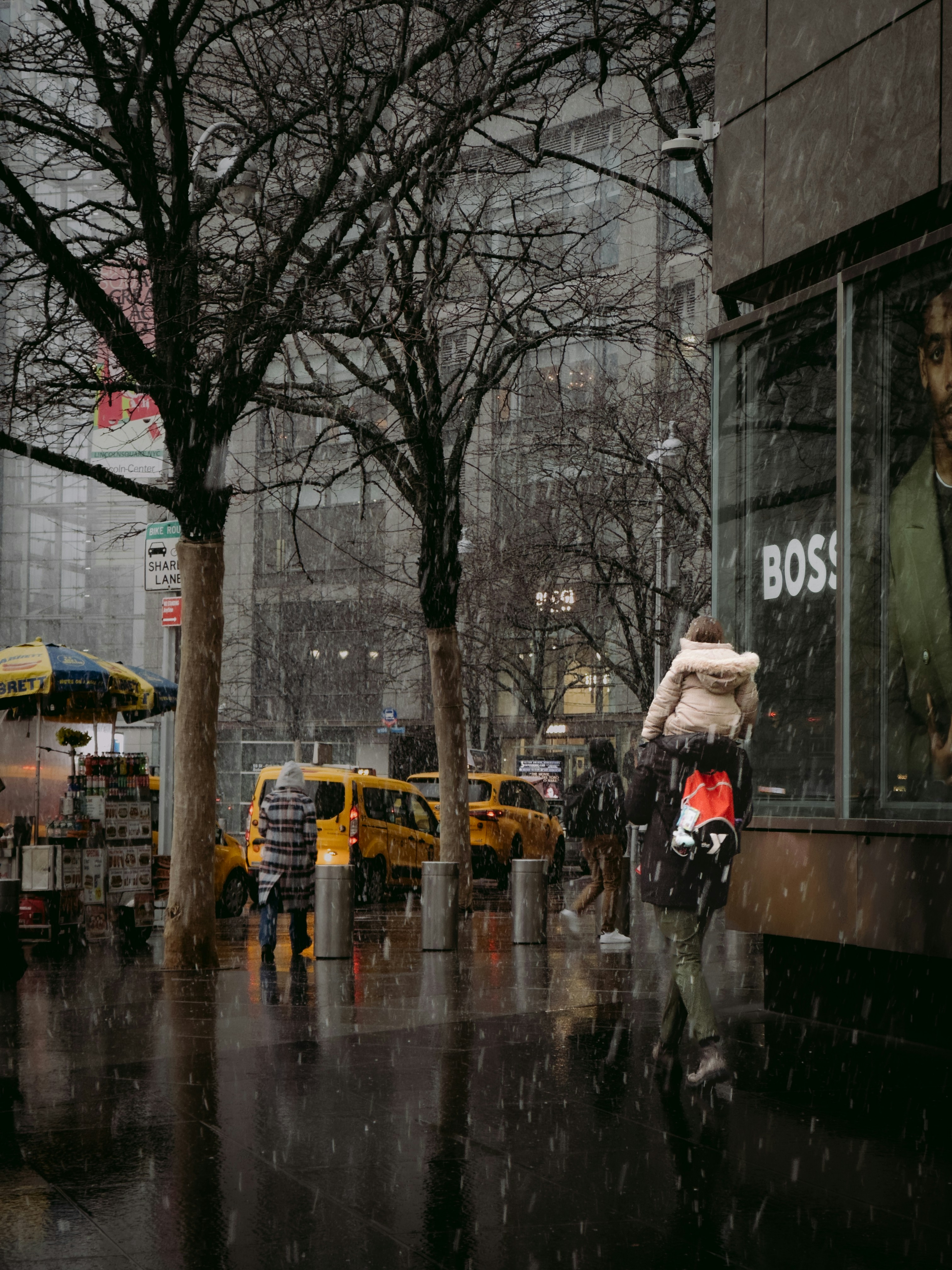 City Rain: A Pedestrian Paused under Snowy Veil
