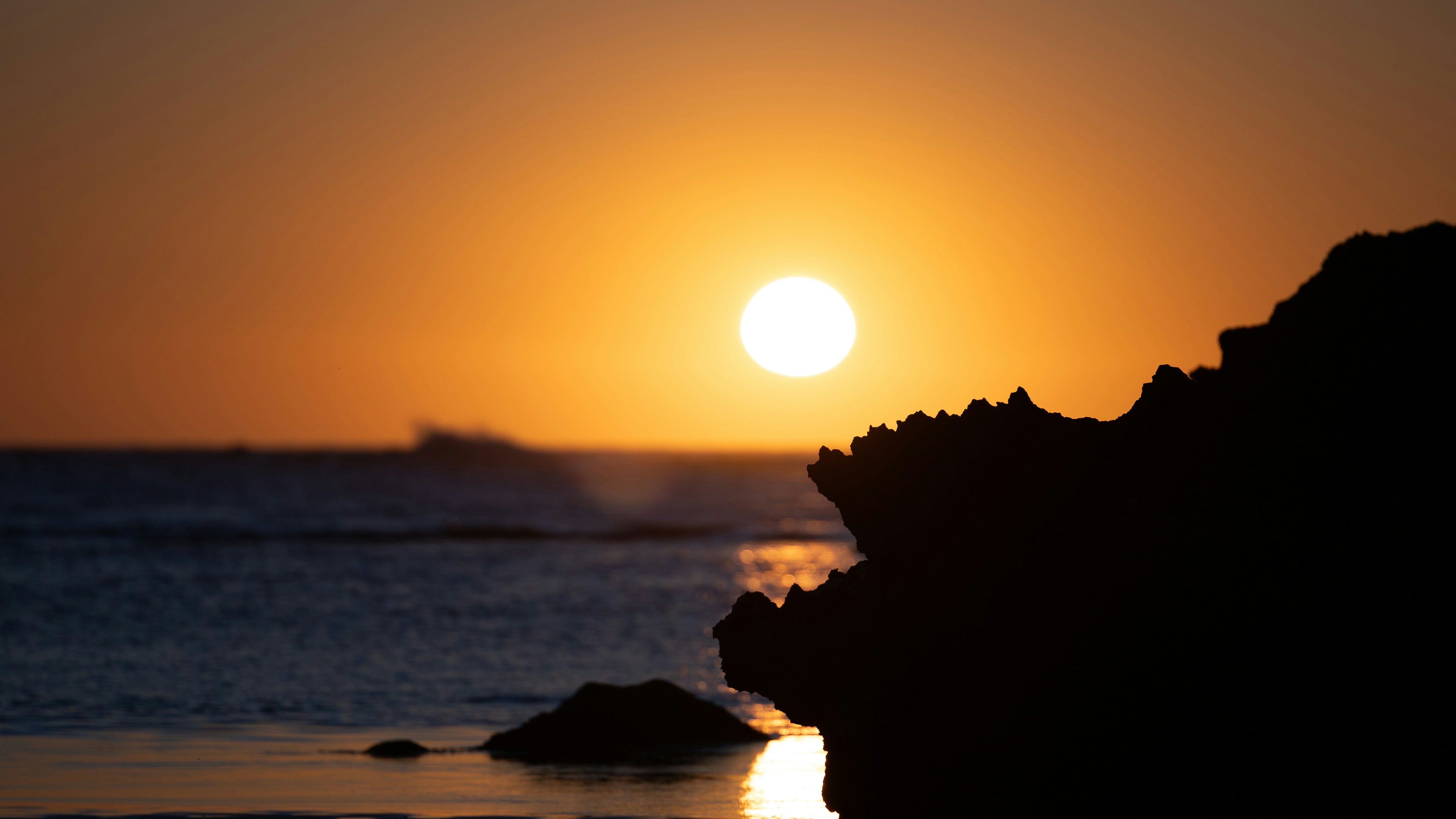 Sunlit Silhouette at Dusk over a Reservoir of Quiet Waves
