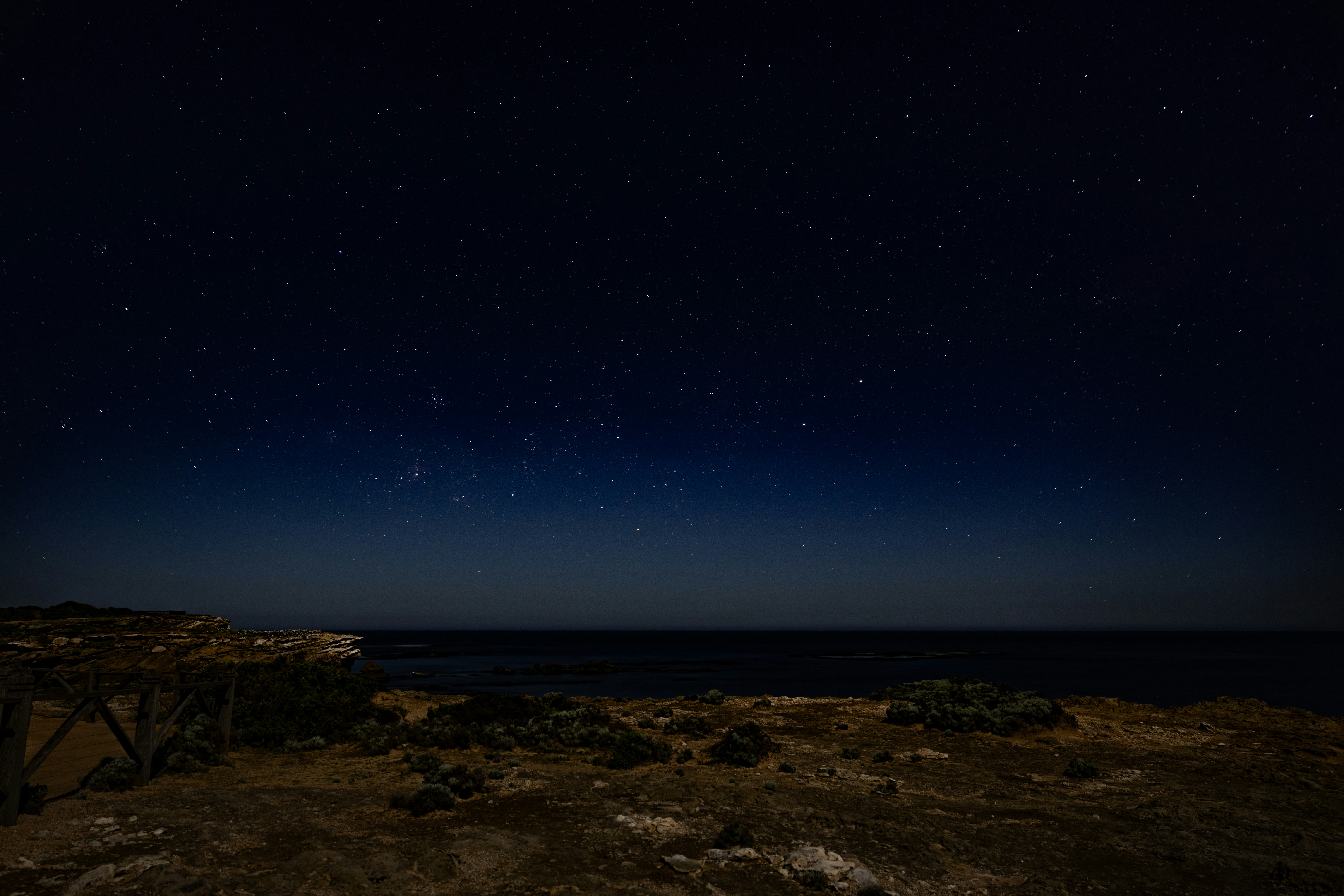 Starfield Over a Quiet Coastal Rim