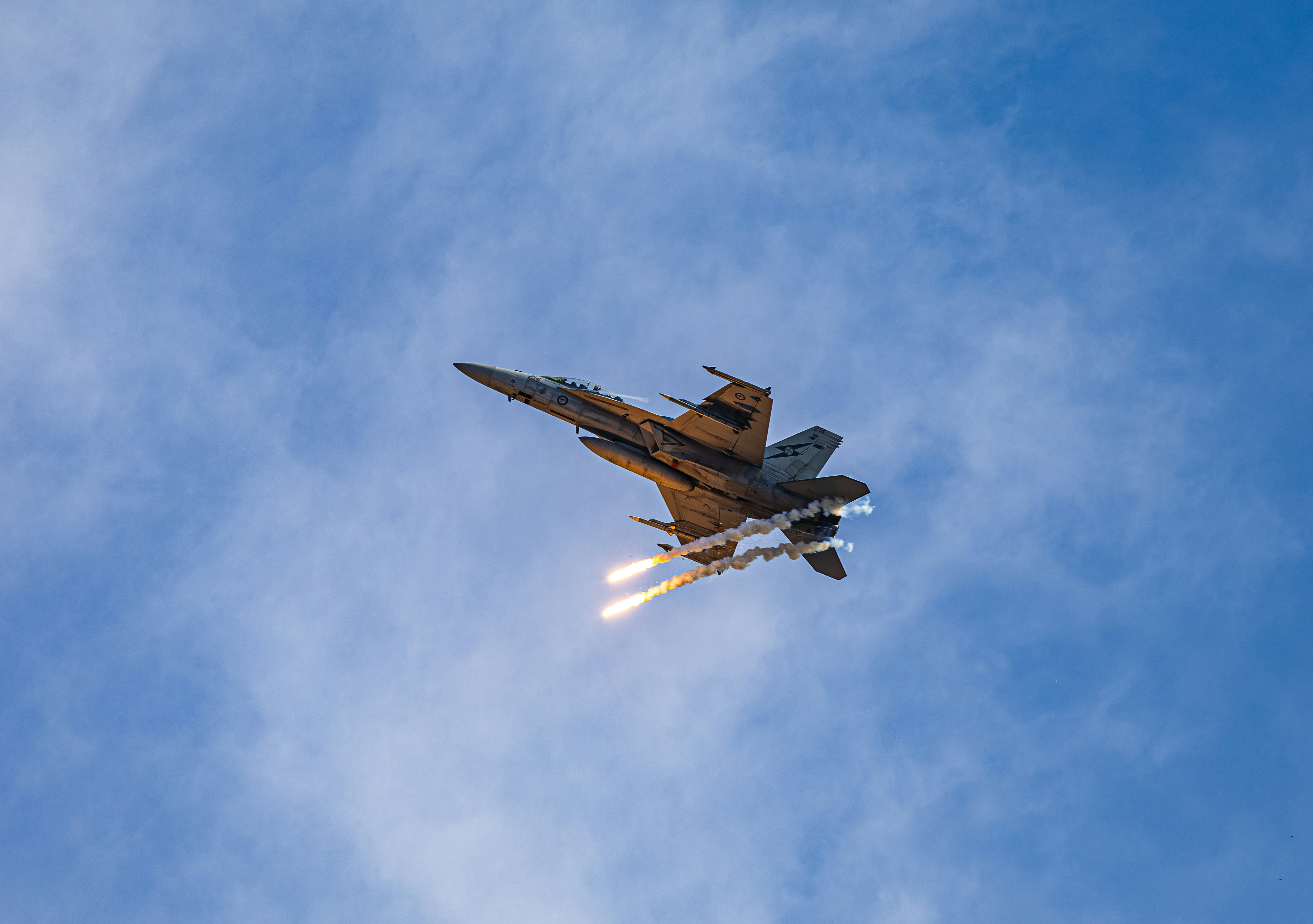 Afterburner Ink: A Jet Pierces Through a Blue Canvas