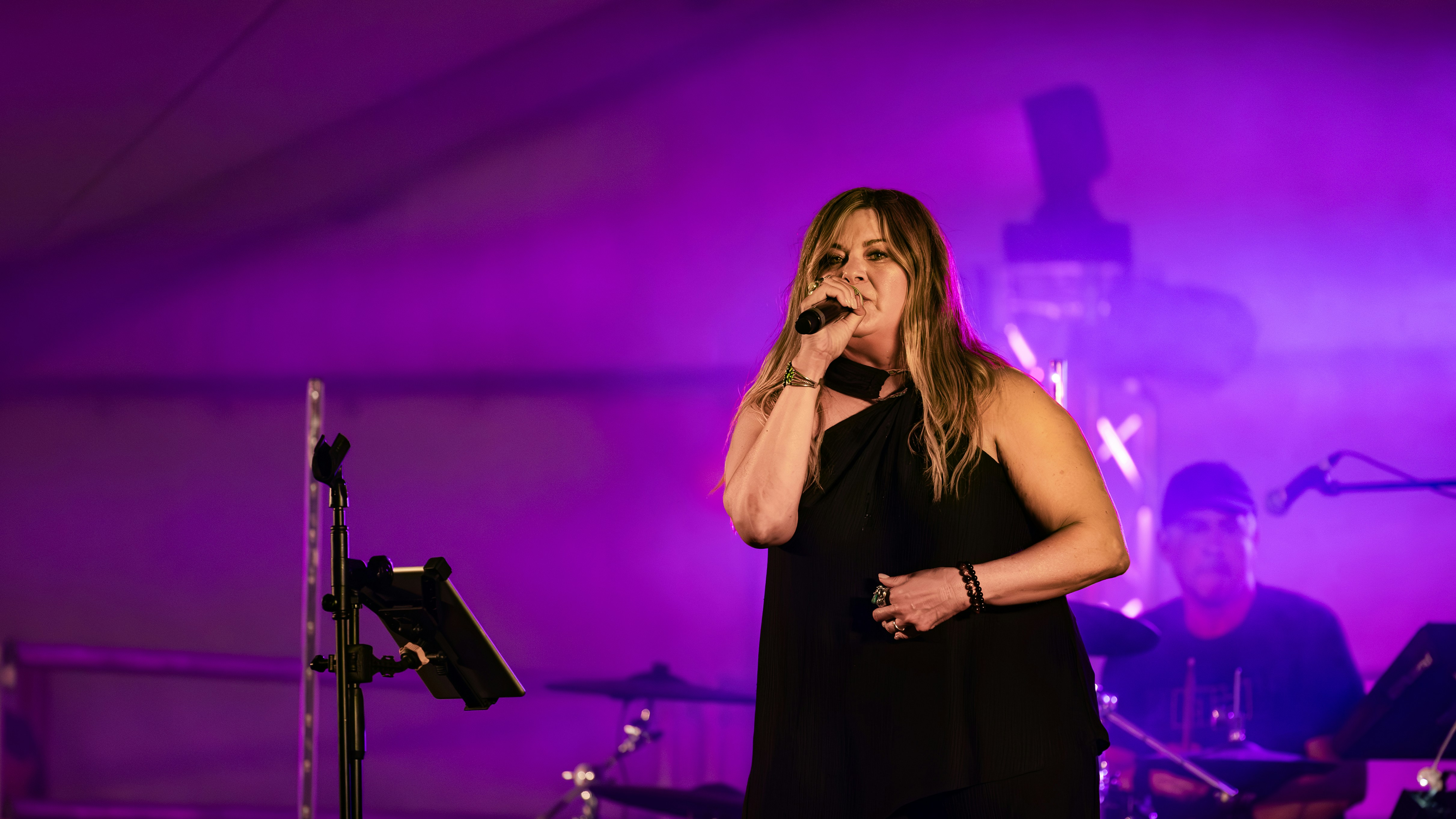 Midlife Rock Pulse: A vocalist under magenta stage glow