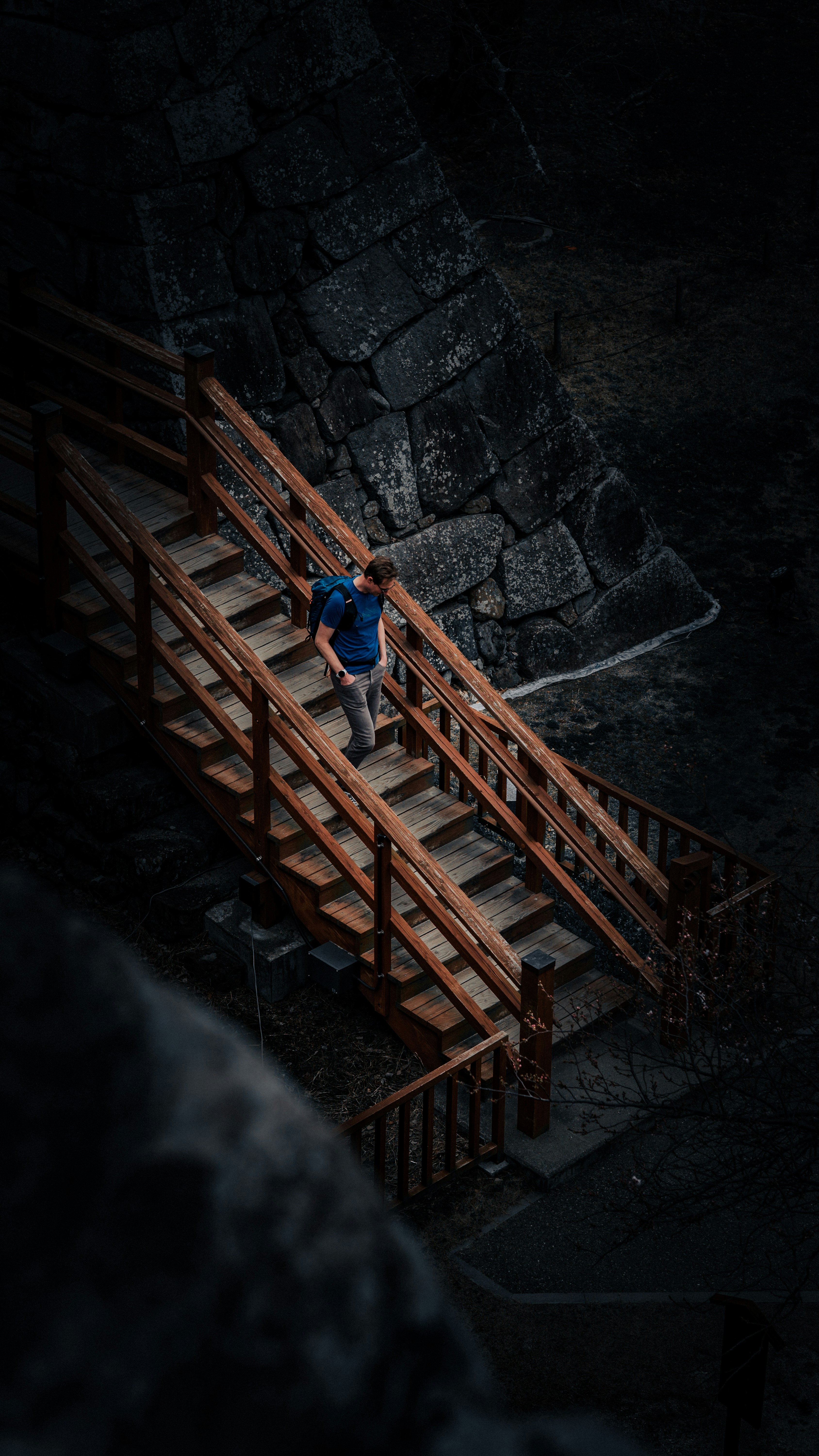 Cliffside Ascent: A Lone Hiker Traverses a Weathered Staircase
