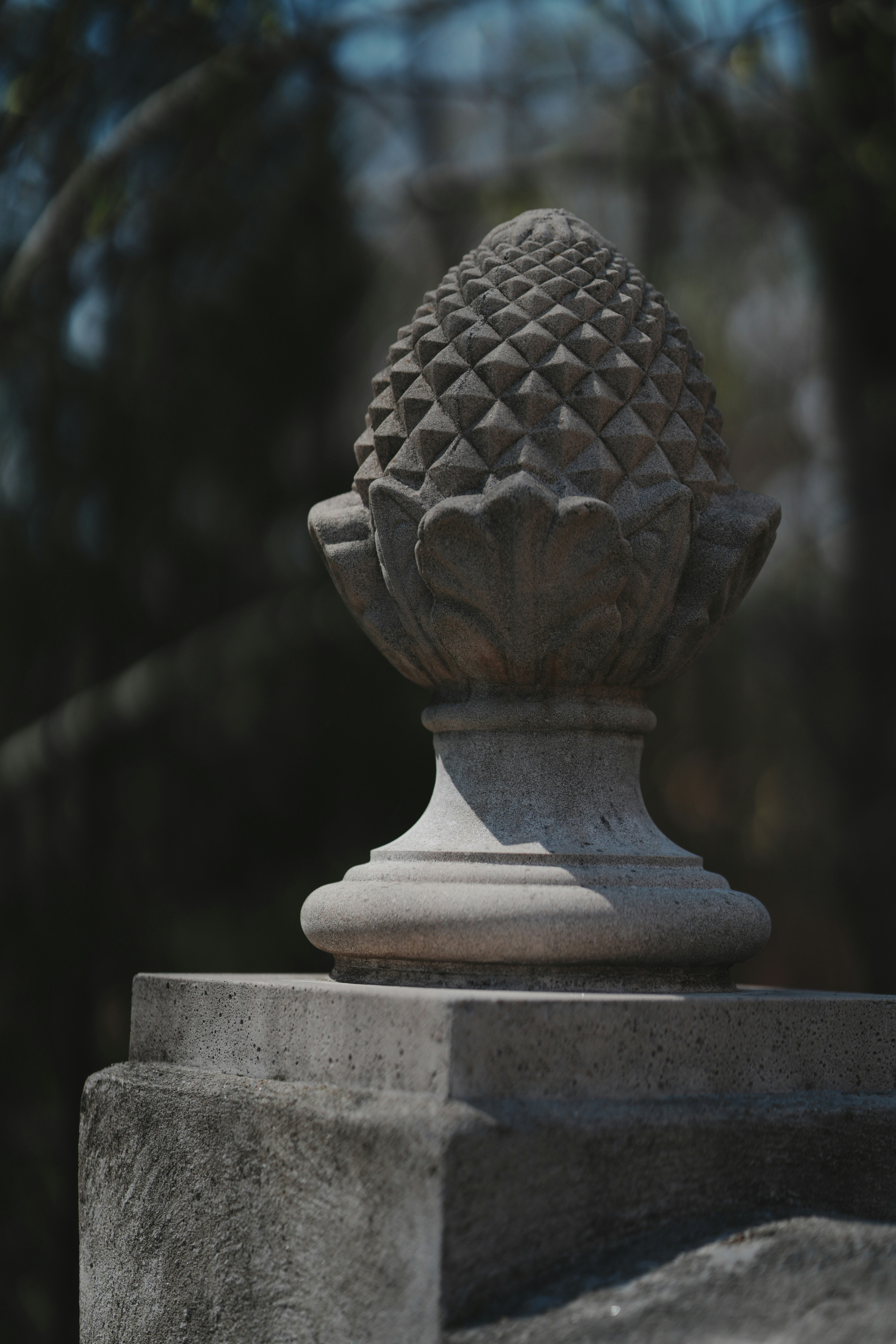 Pinecone Finial: A Weathered Stone Ornament in Soft Focus