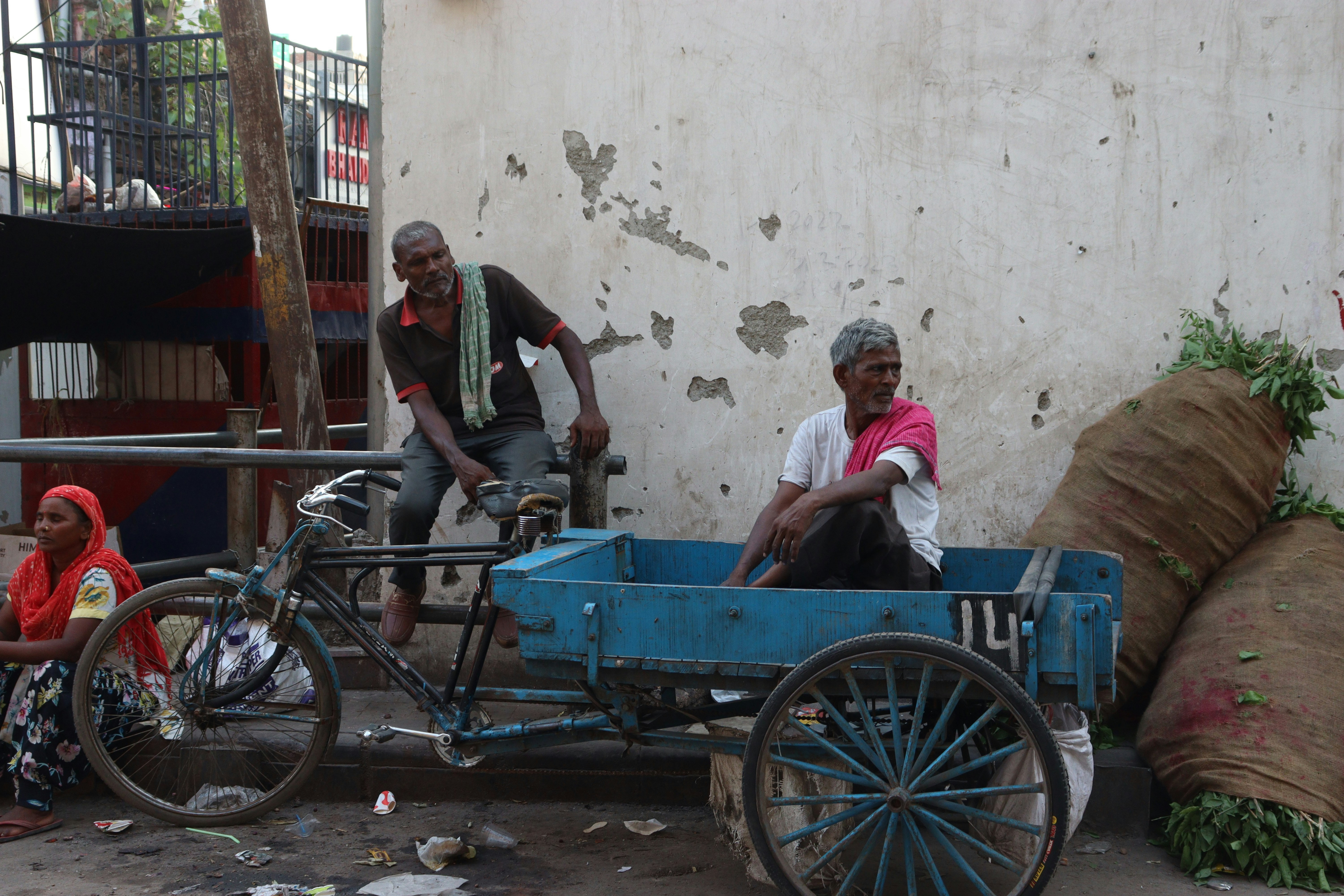 Blue Cart, Red-Headed Figure: A Street Moment in Quiet Tumble
