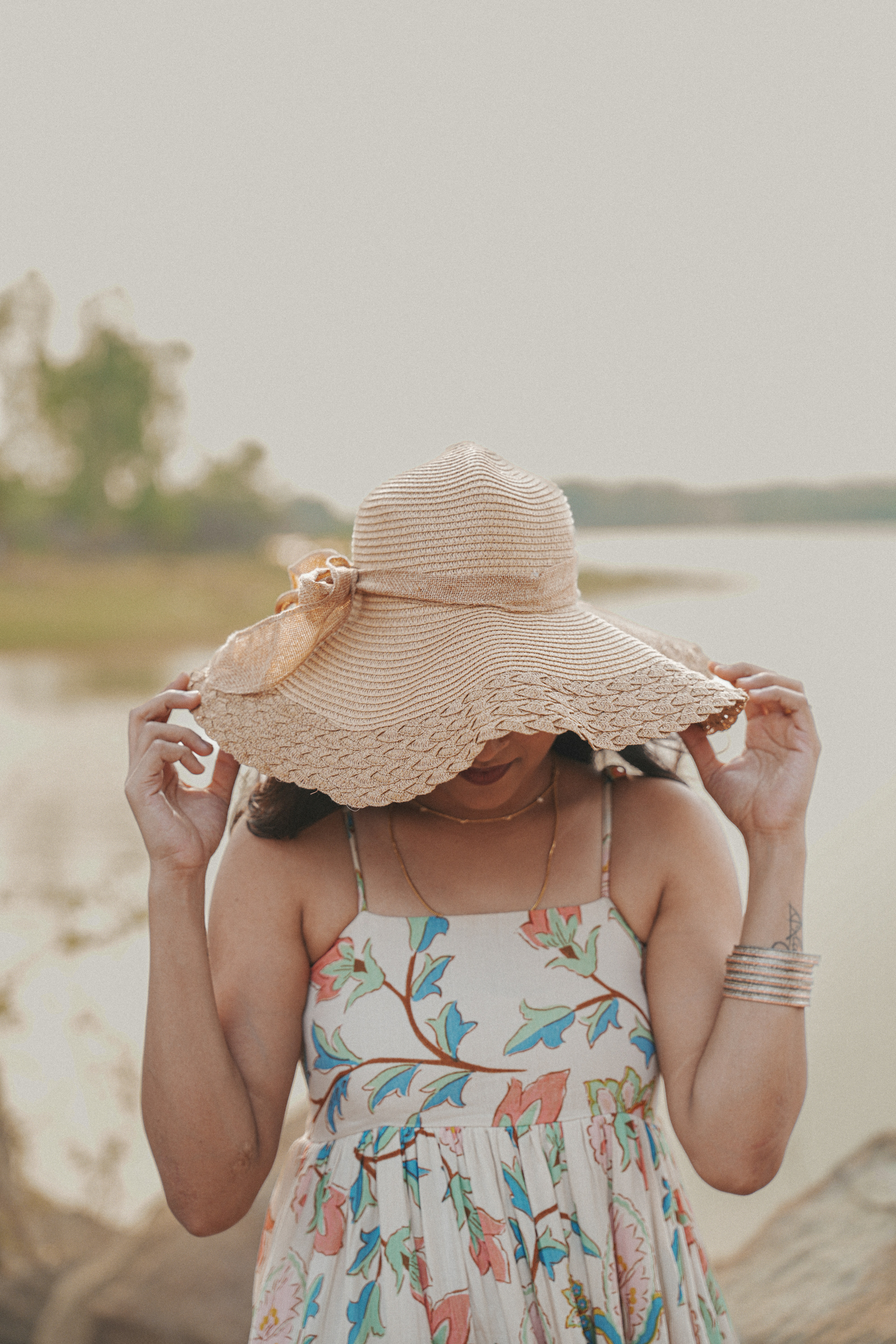 Sunlit Straw Hat Portrait by the Water
