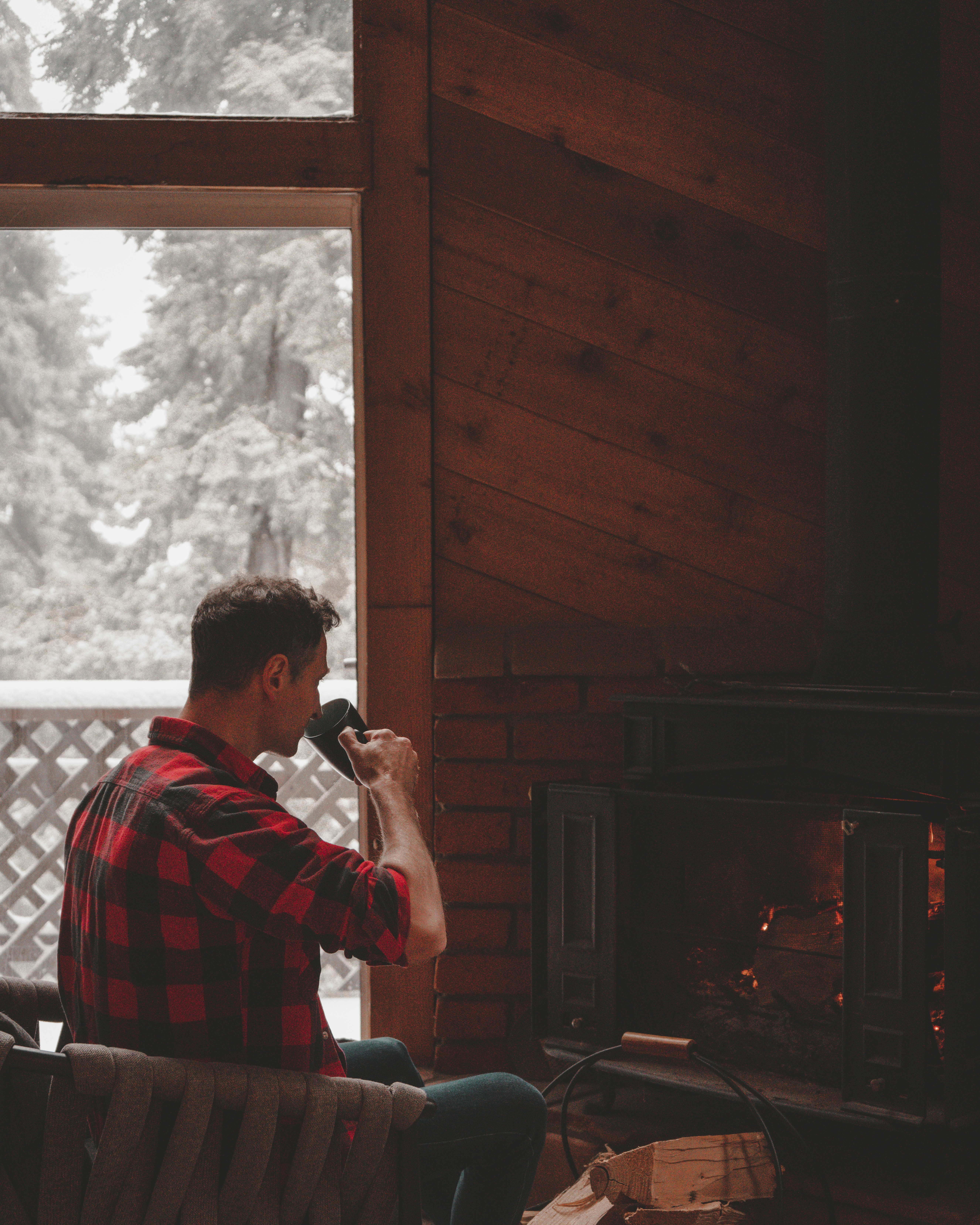 Cozy Ember: A Man in Plaid at the Fireplace