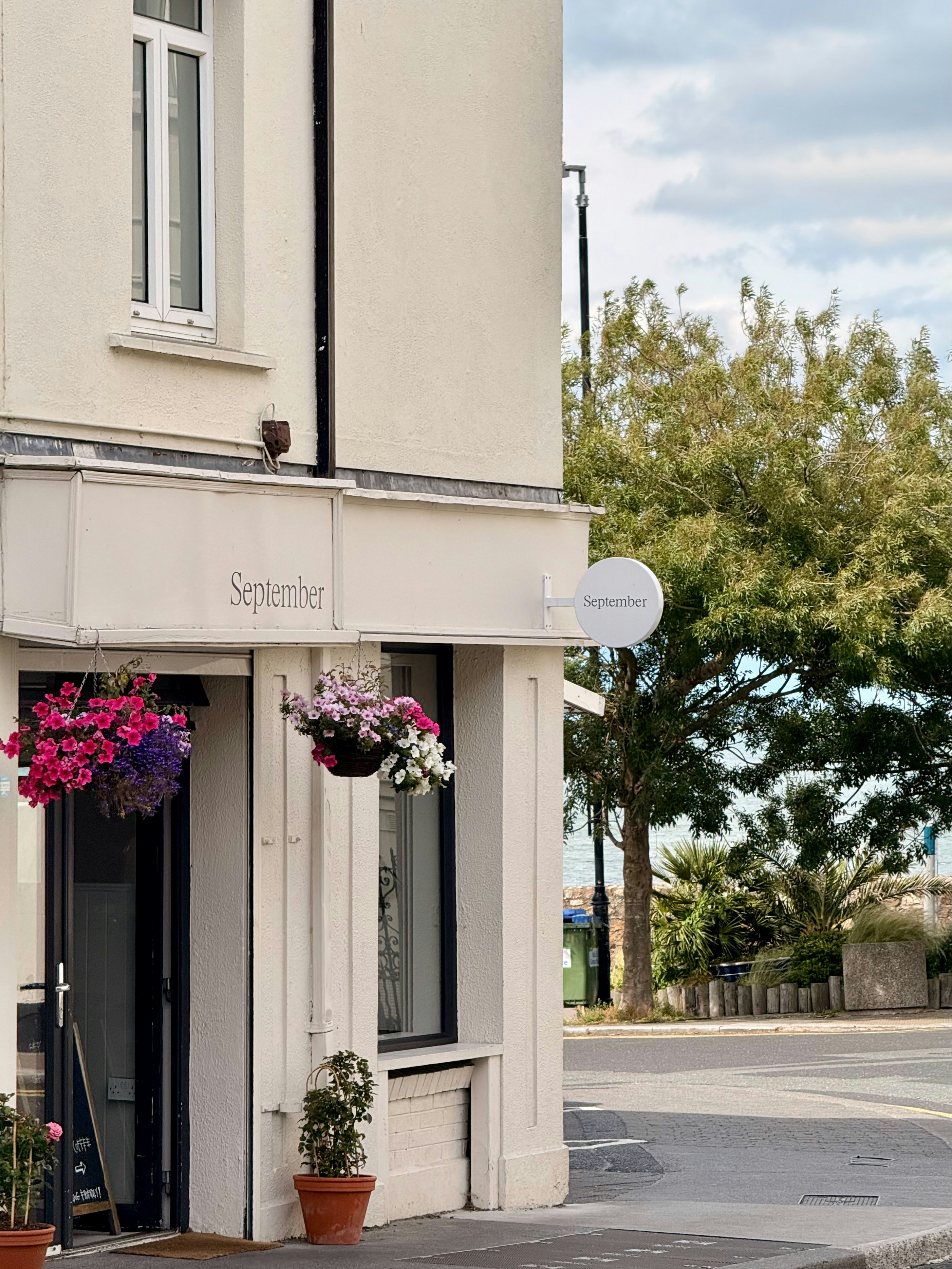 September storefront on a sunlit seaside street