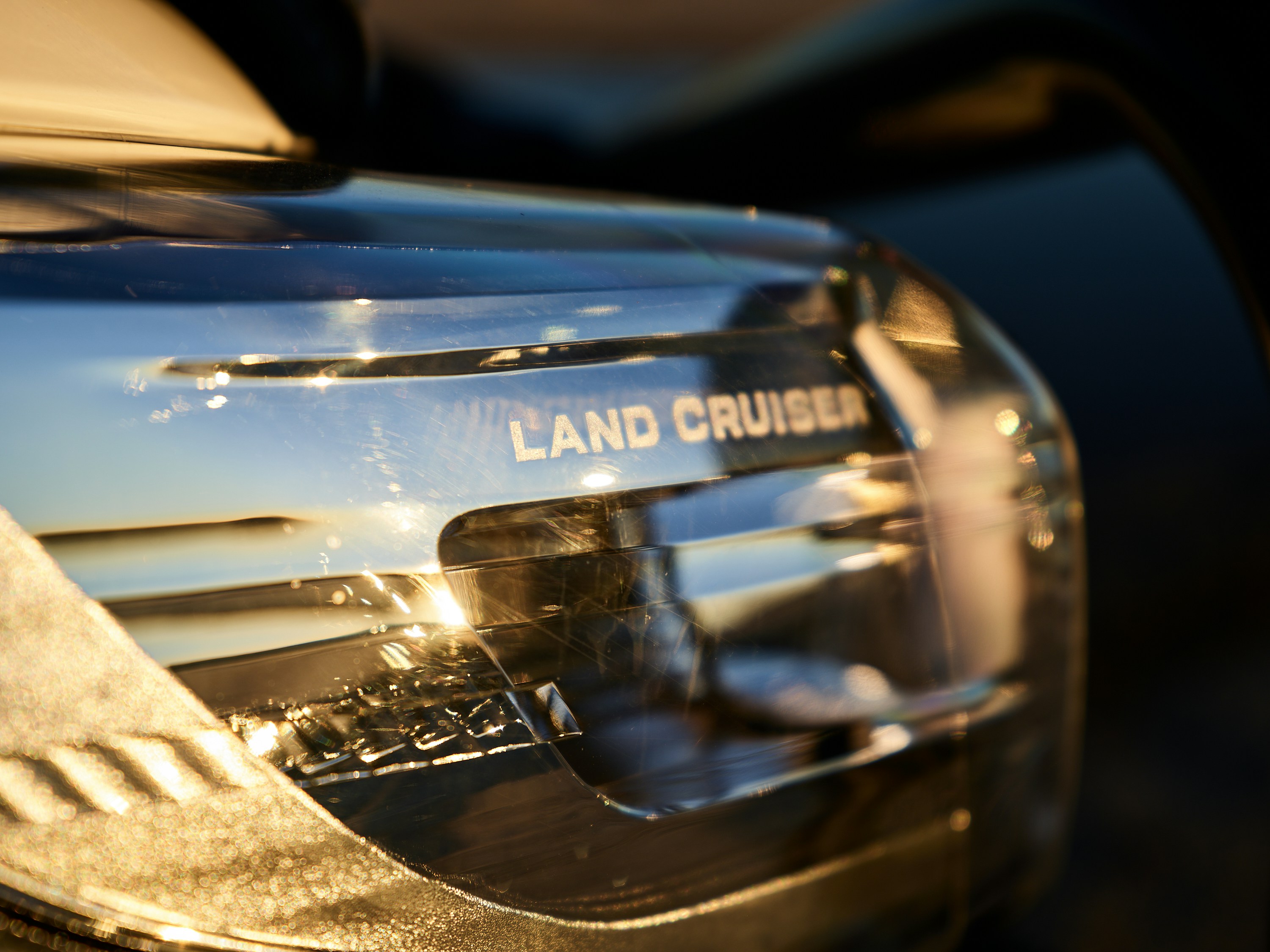 Liquid Chrome: A Close-Up of the Land Cruiser Badge and Grill