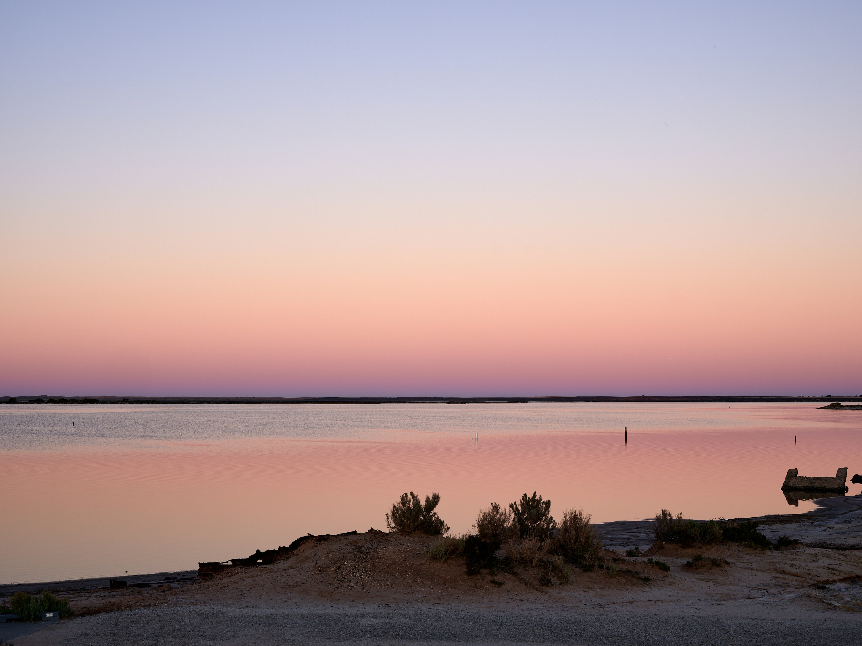 Horizon Rest at Sunset: Calm Waters Meet Quiet Shore
