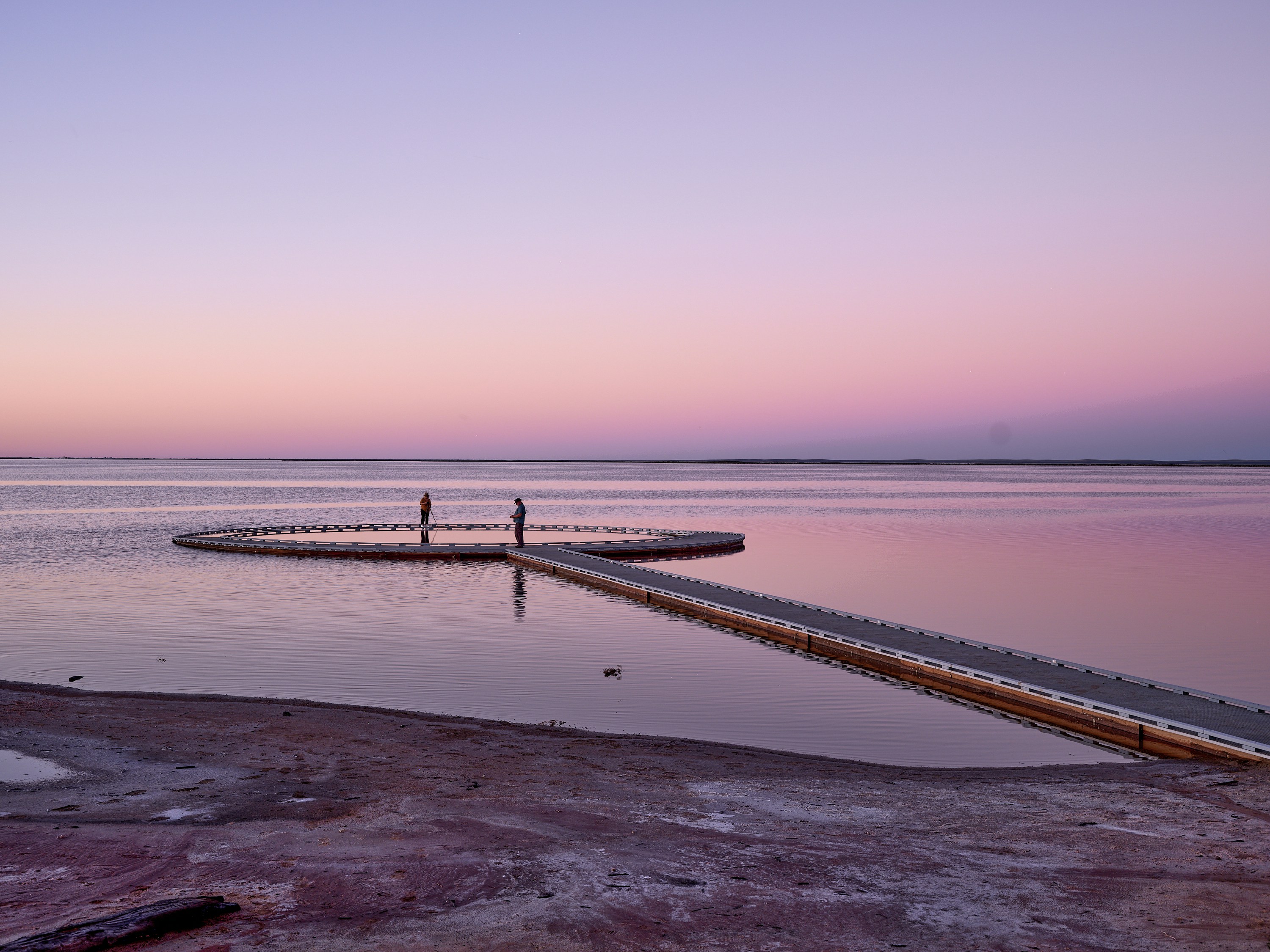 Pastel Pier: Two Figures at the Quiet Edge of Sunset
