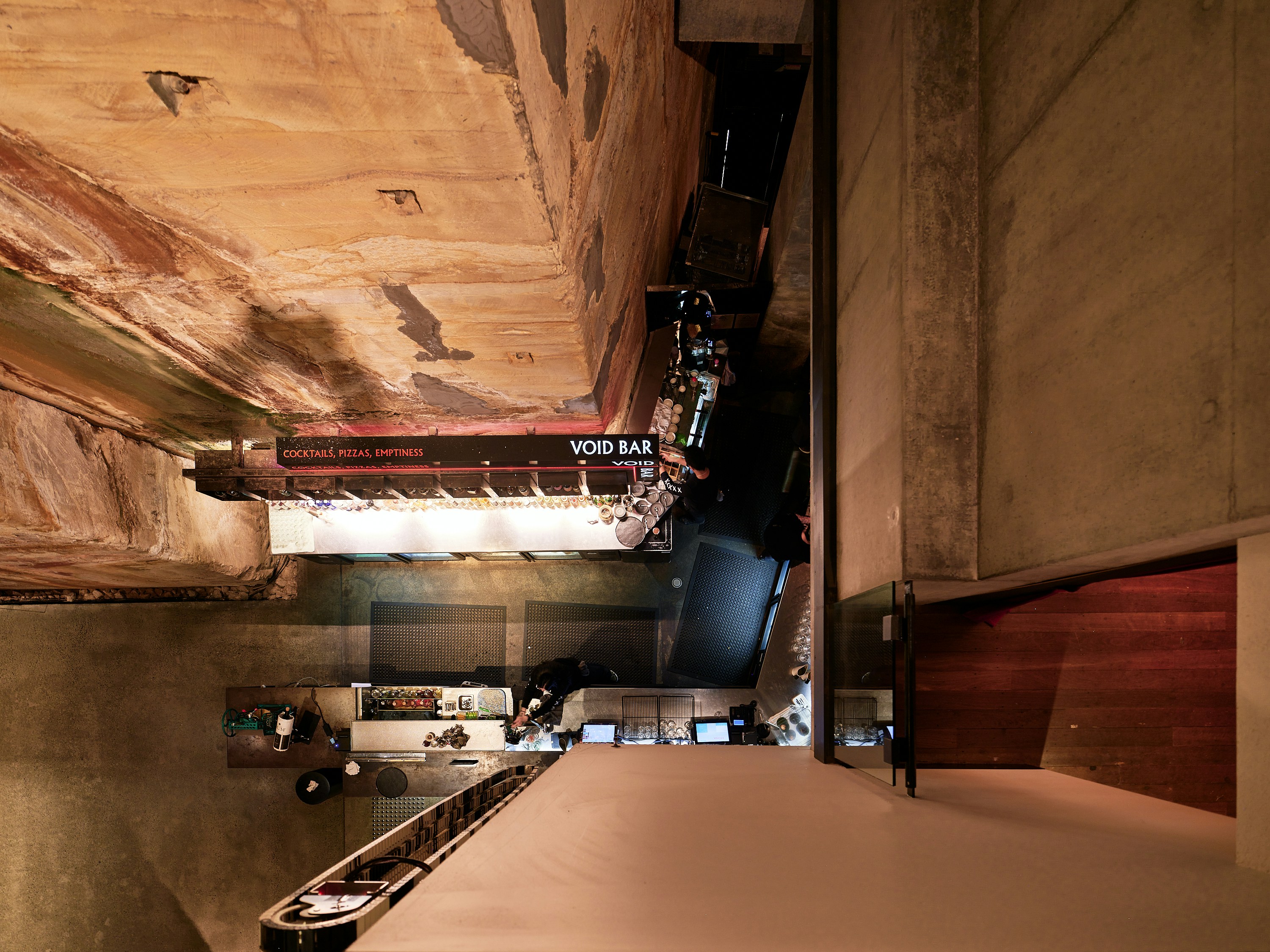 Void Bar from a Concrete Canyon: A Nighttime Rooftop Drop