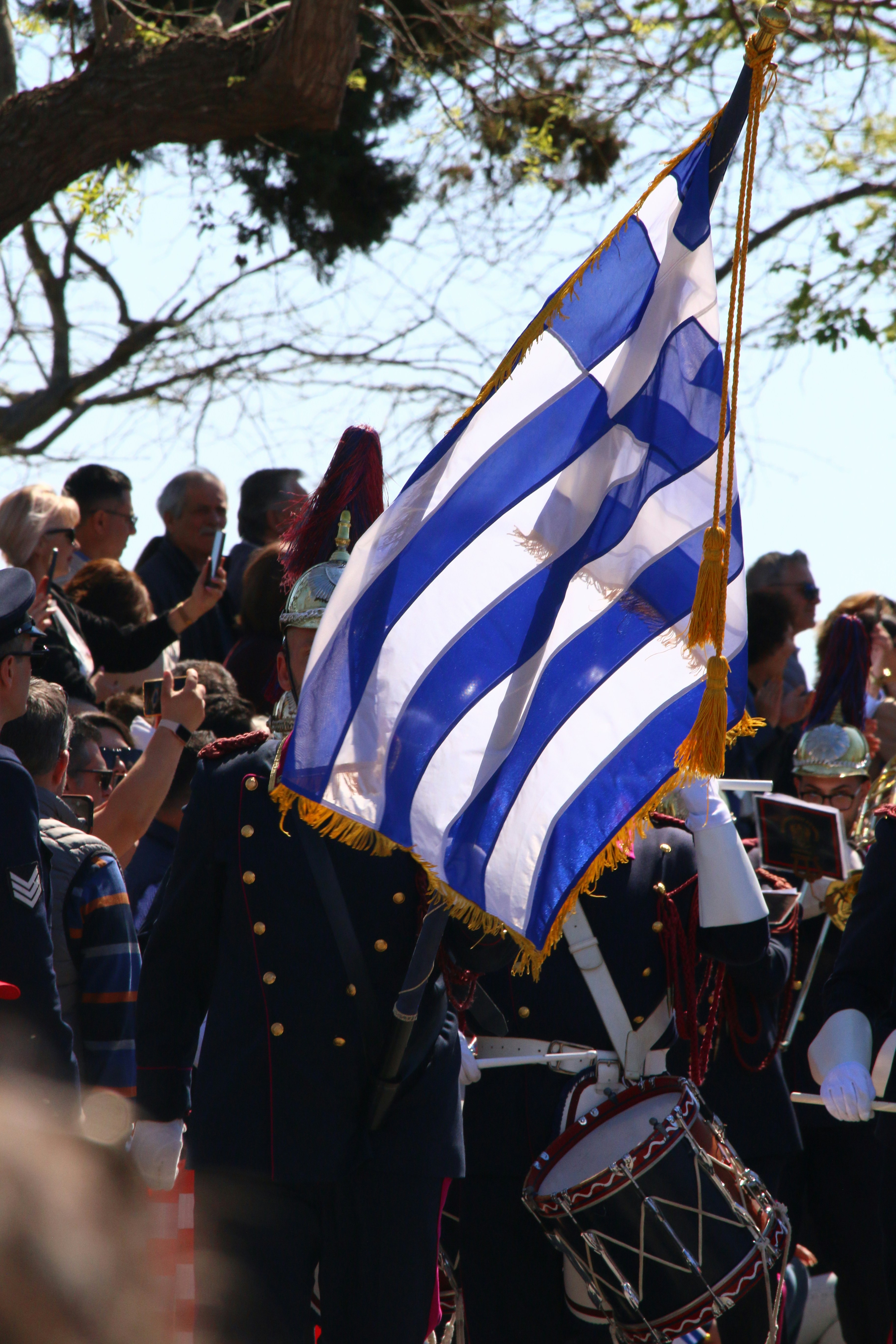 Flag-Borne Parade: Blue and White Stripes Cut Through a Crowd