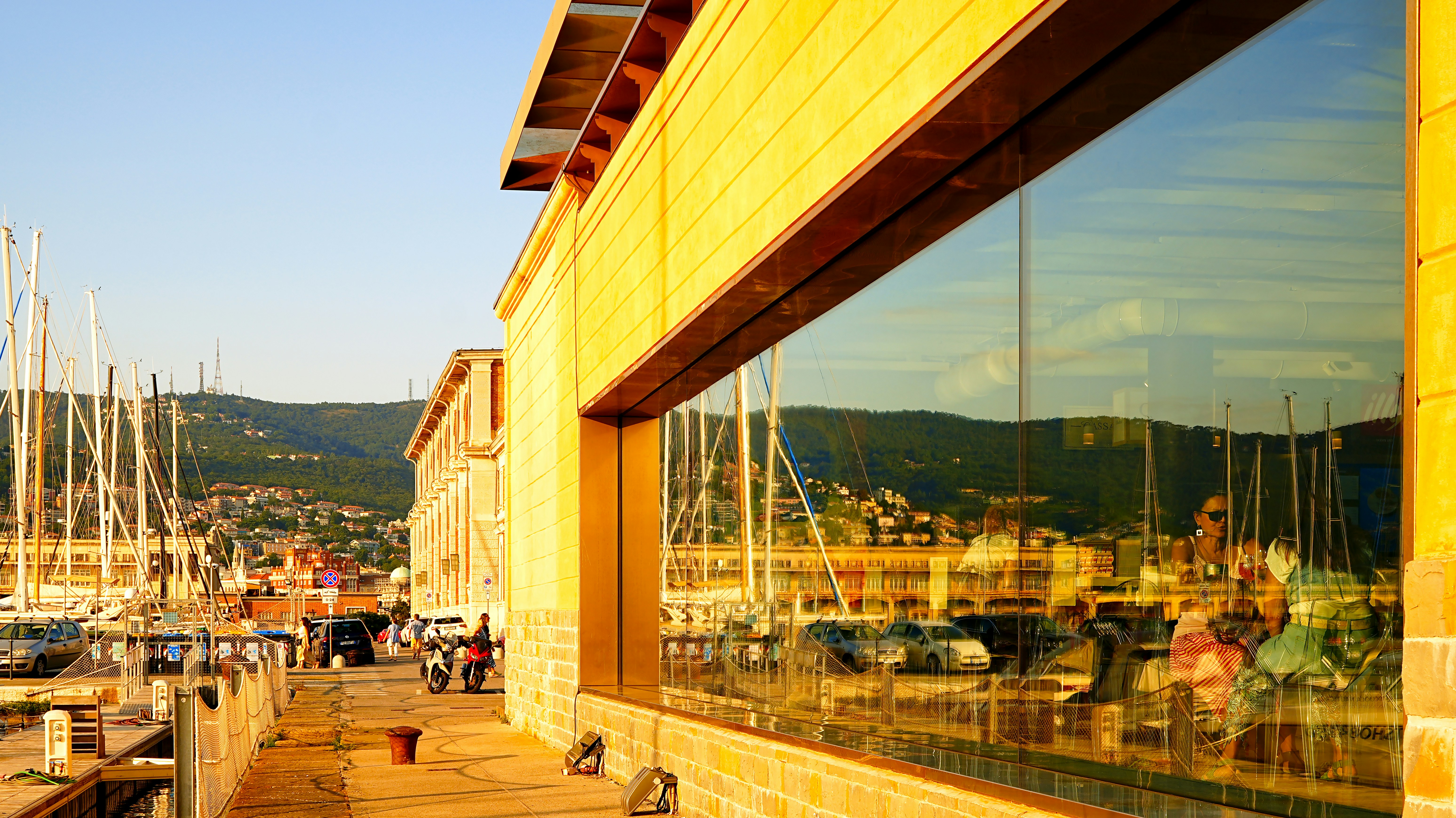 Golden Harborfront: Reflections and Rigs at Dusk