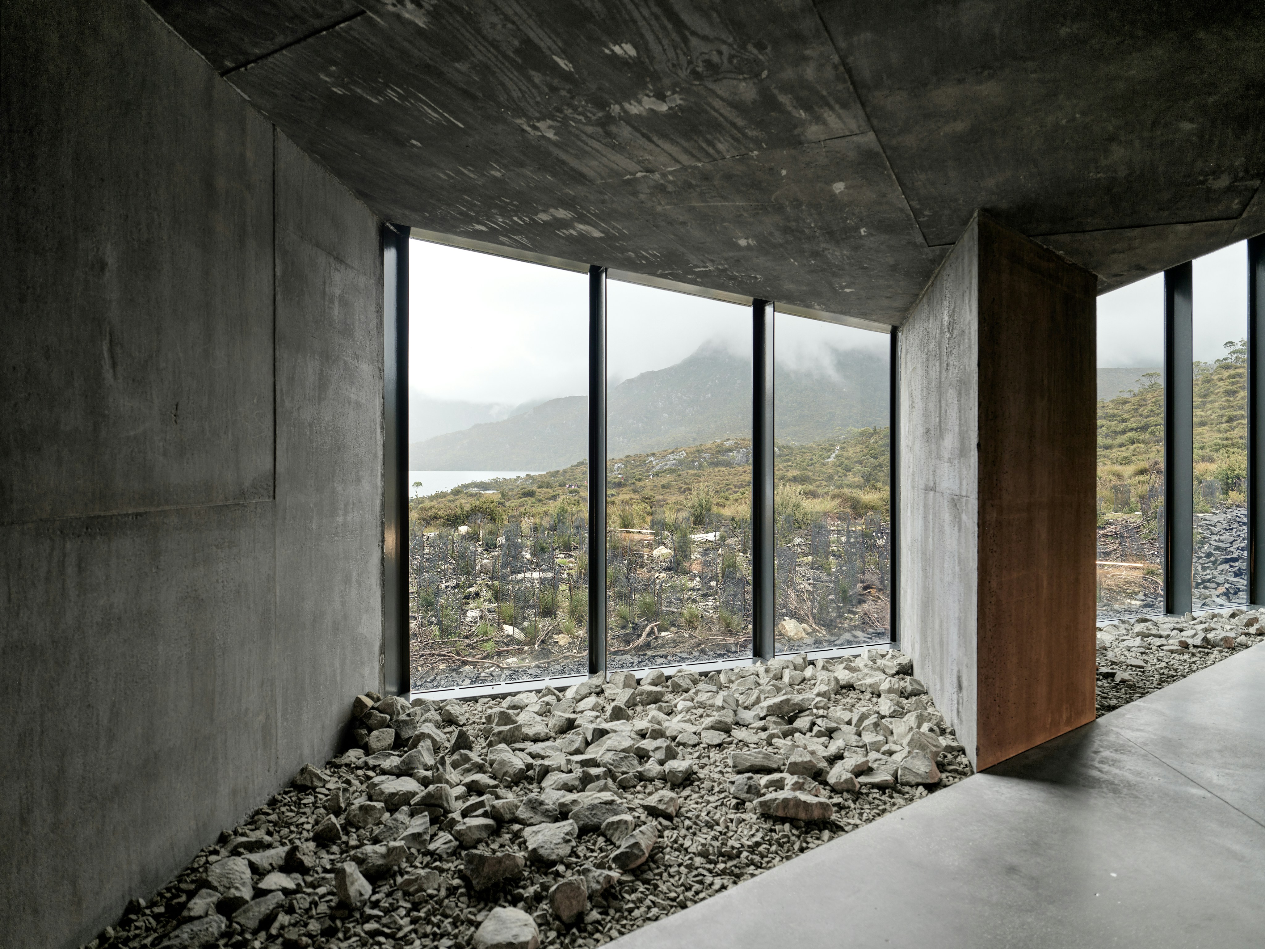 Windowed Void: Concrete Room Framing a Mountain Panorama