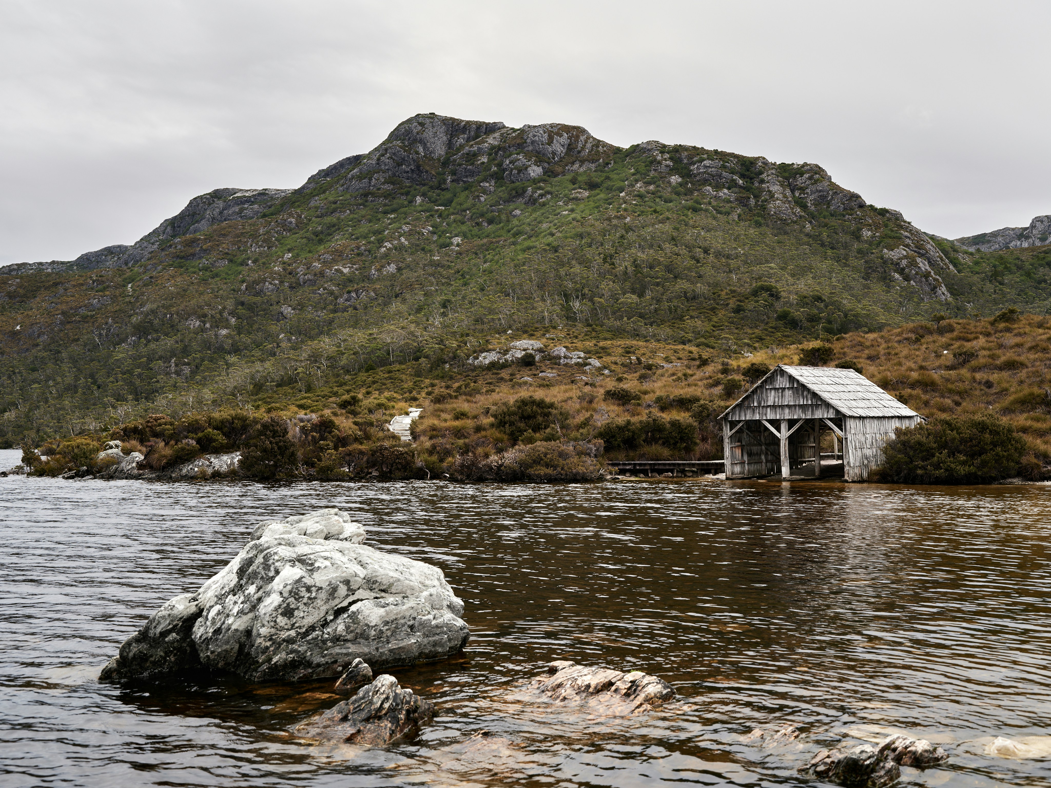 Hidden Lakeside Hut at the Foot of a Rugged Moor