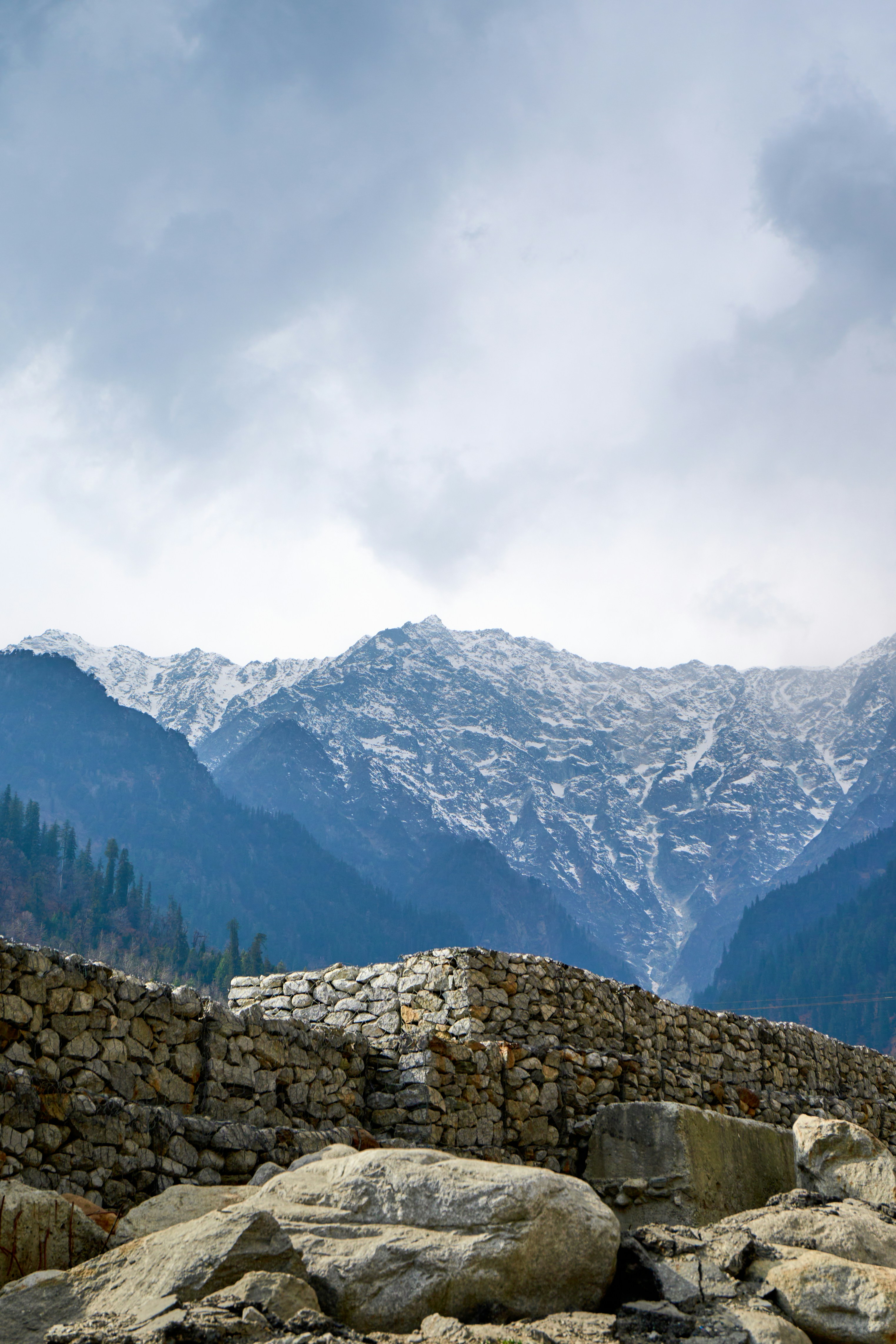 Stone Wall at the Threshold of Snow-Dusted Peaks