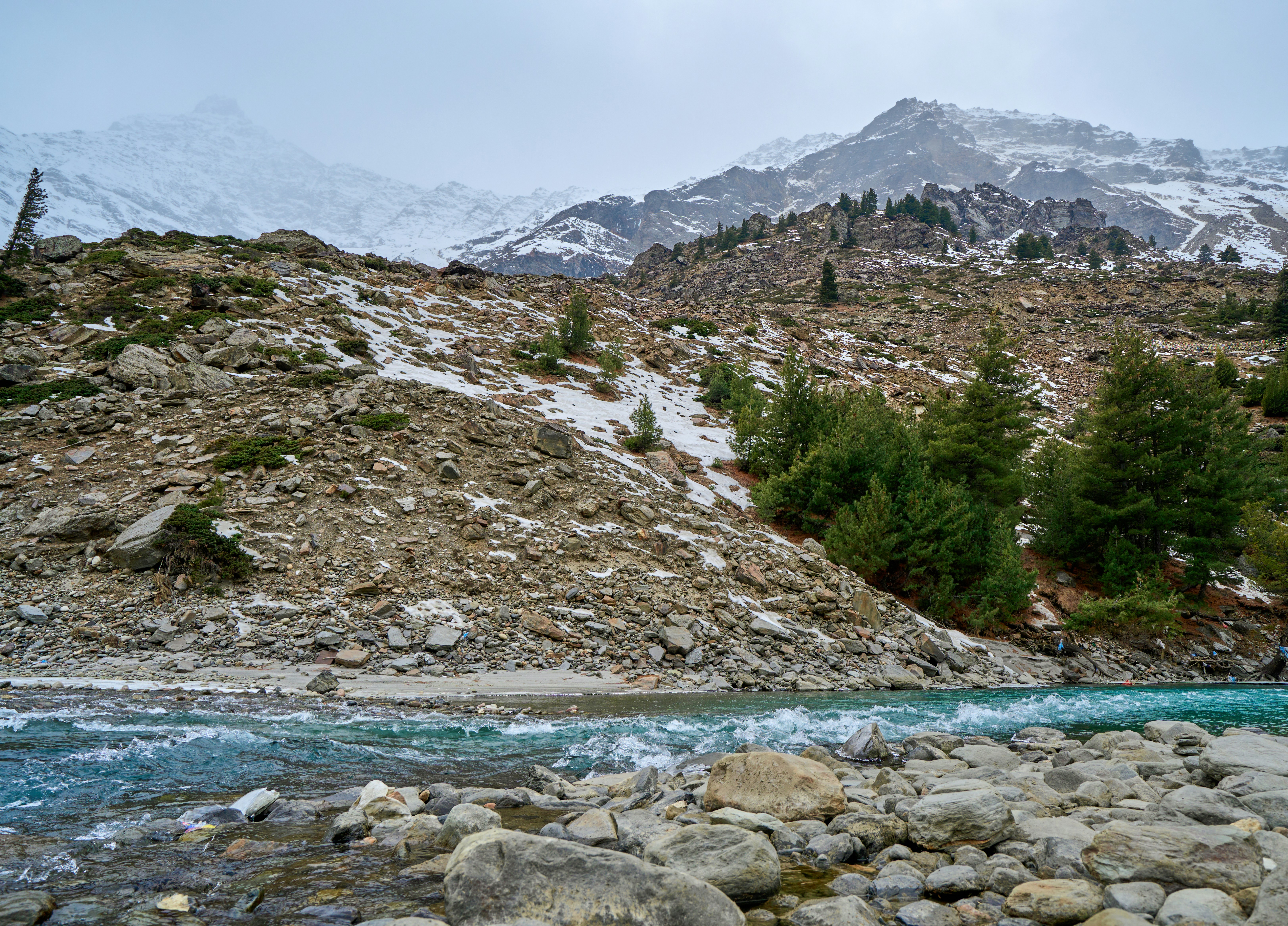 Rugged Alpine Reach by a Turquoise River