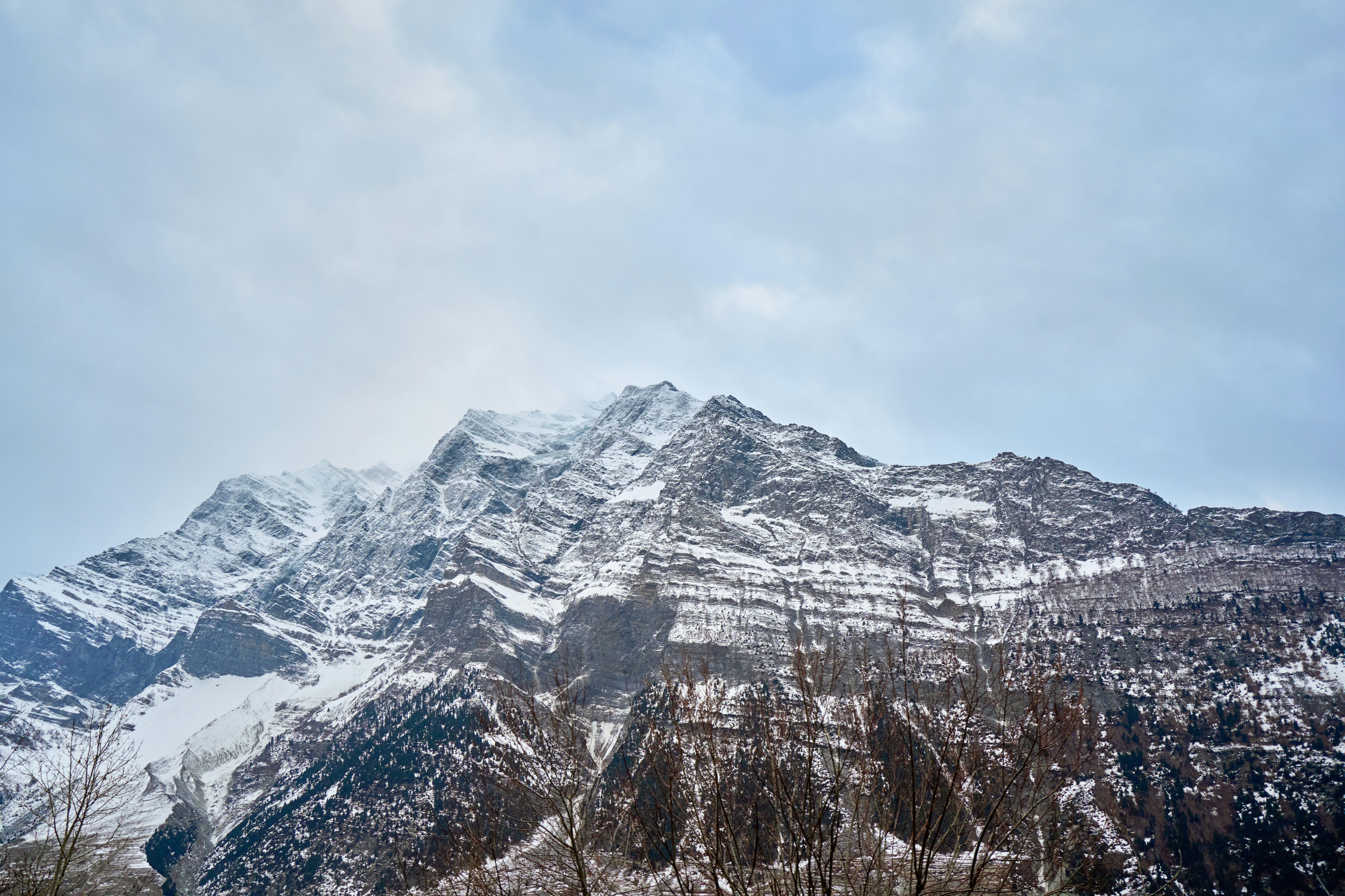 Snowbound Ridge: A Quiet Summit Under Brooding Skies