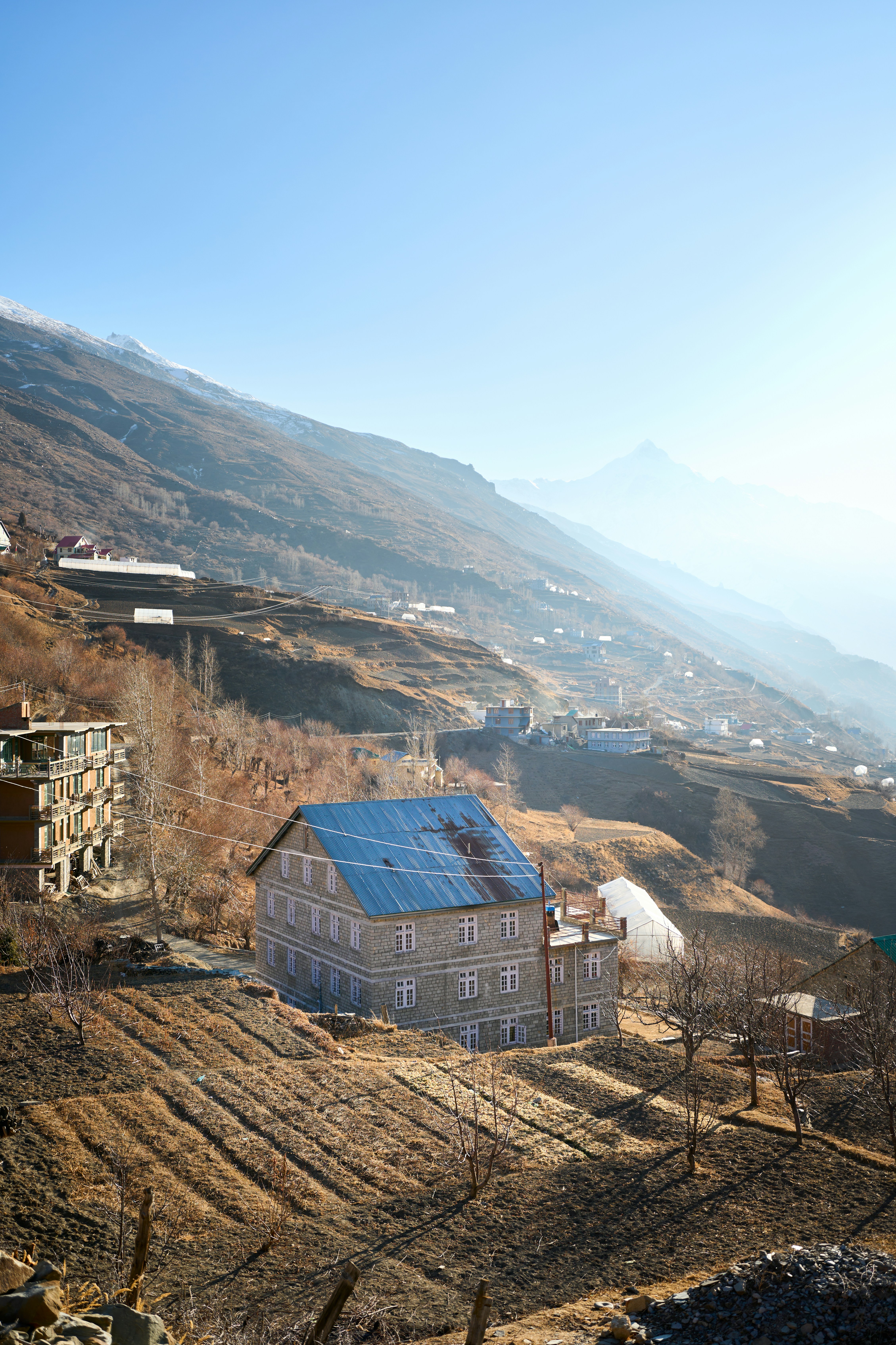 Terraced village under a sweeping alpine horizon