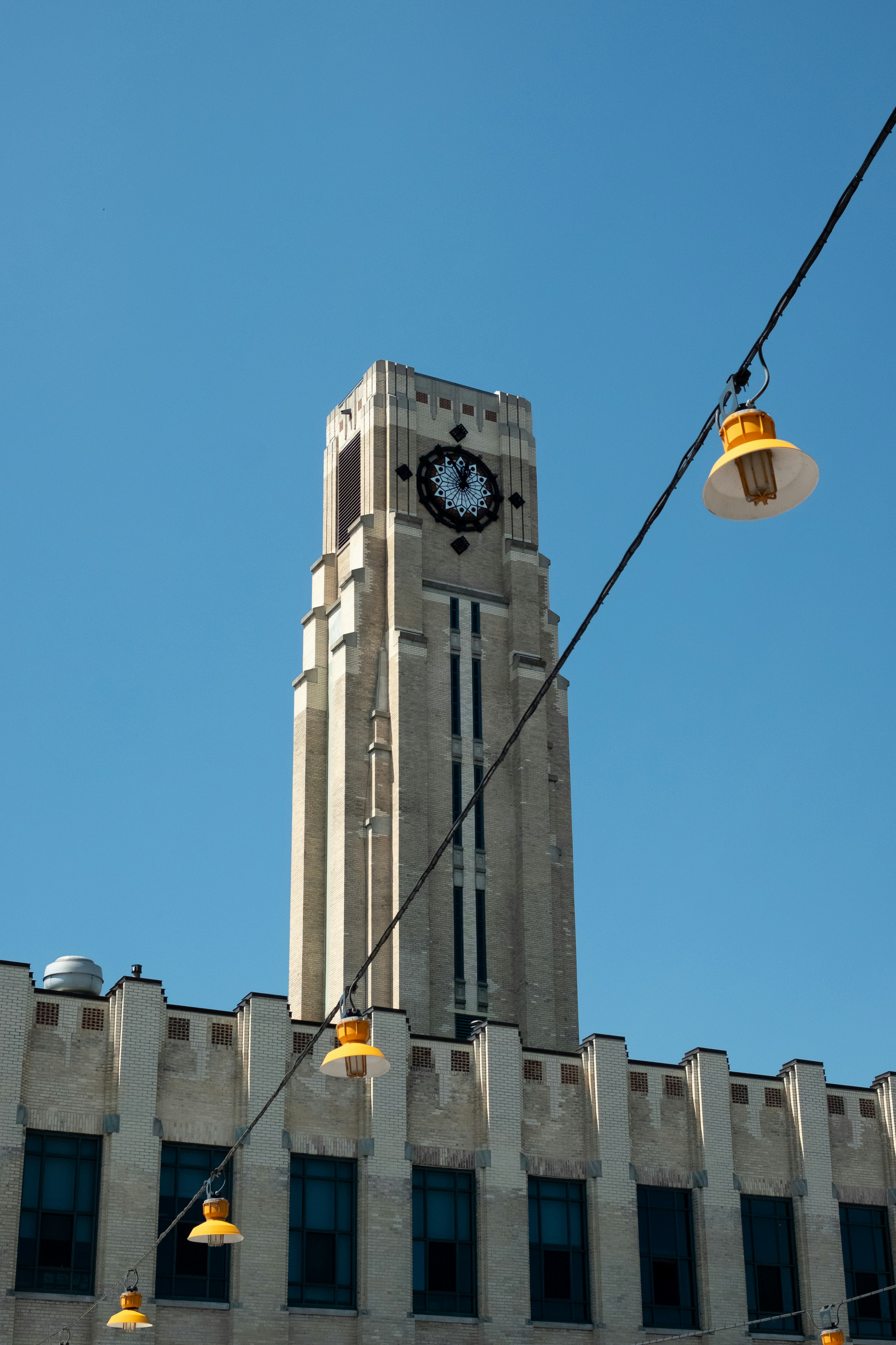 Clocktower in Clear Blue: Urban Geometry Under Cable Lights