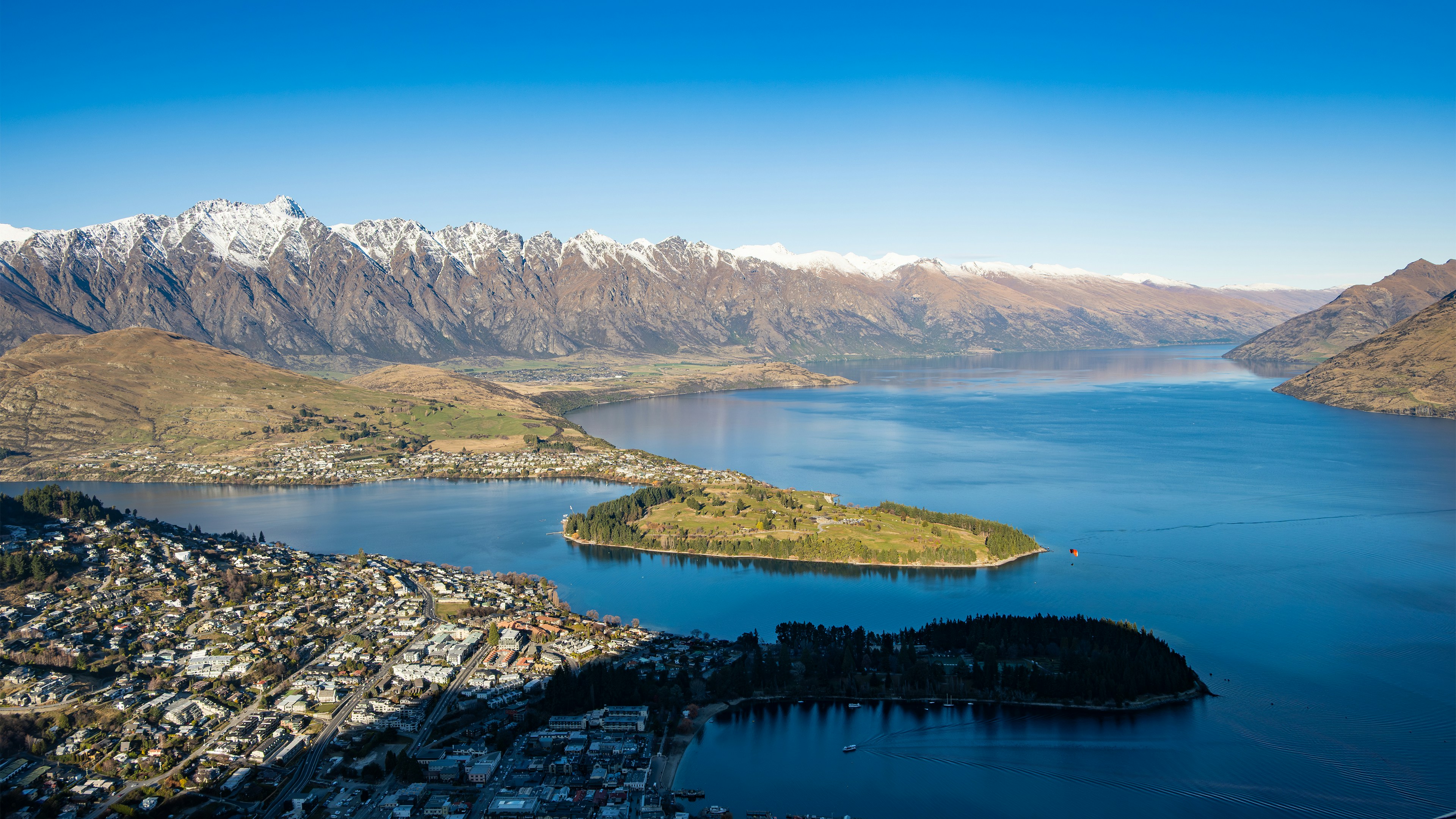 Azure Inlet: Snow-Wedged Peaks Over a Serene Fjord