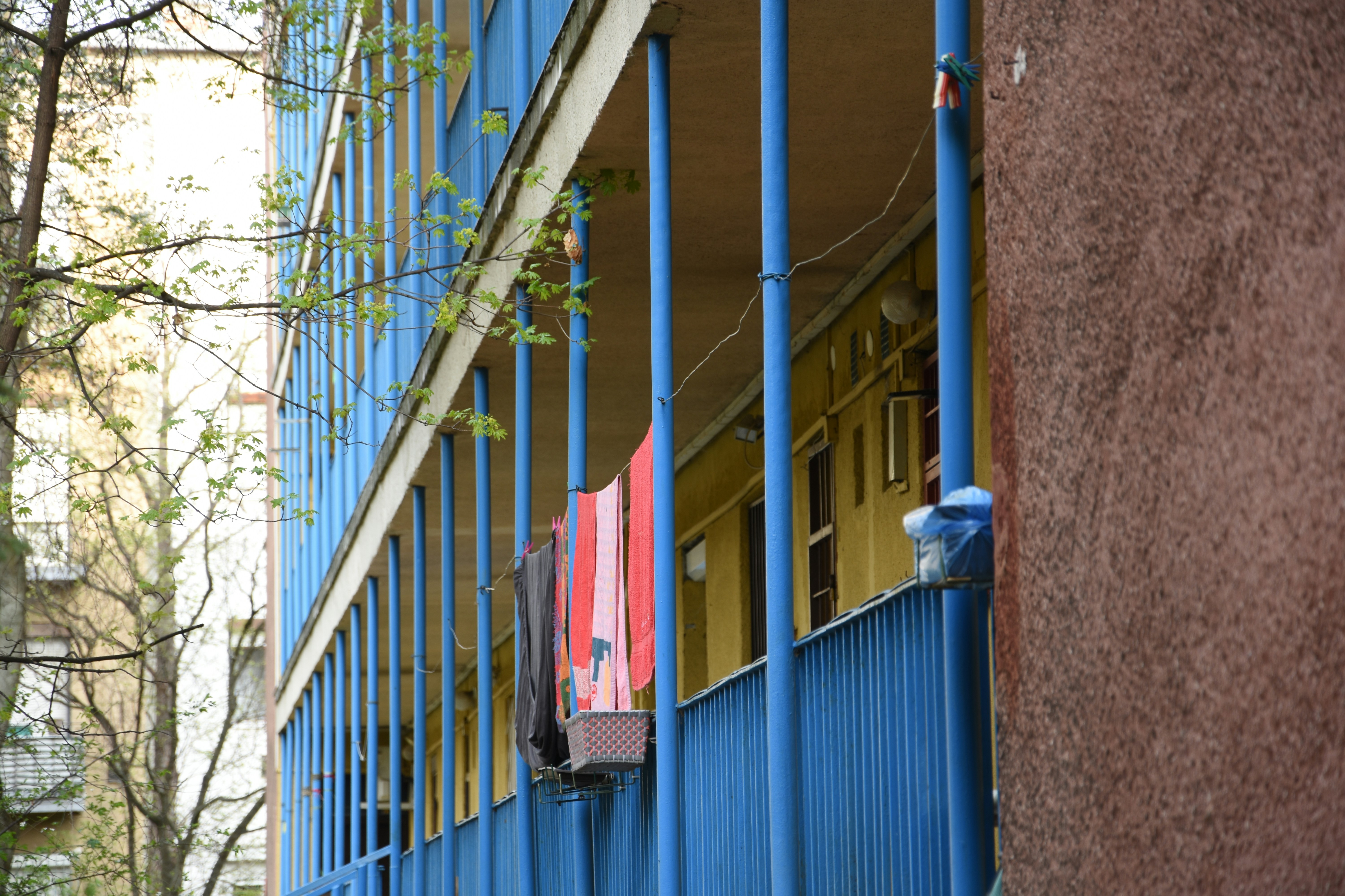Blue Balcony Corridor with Hanging Laundry