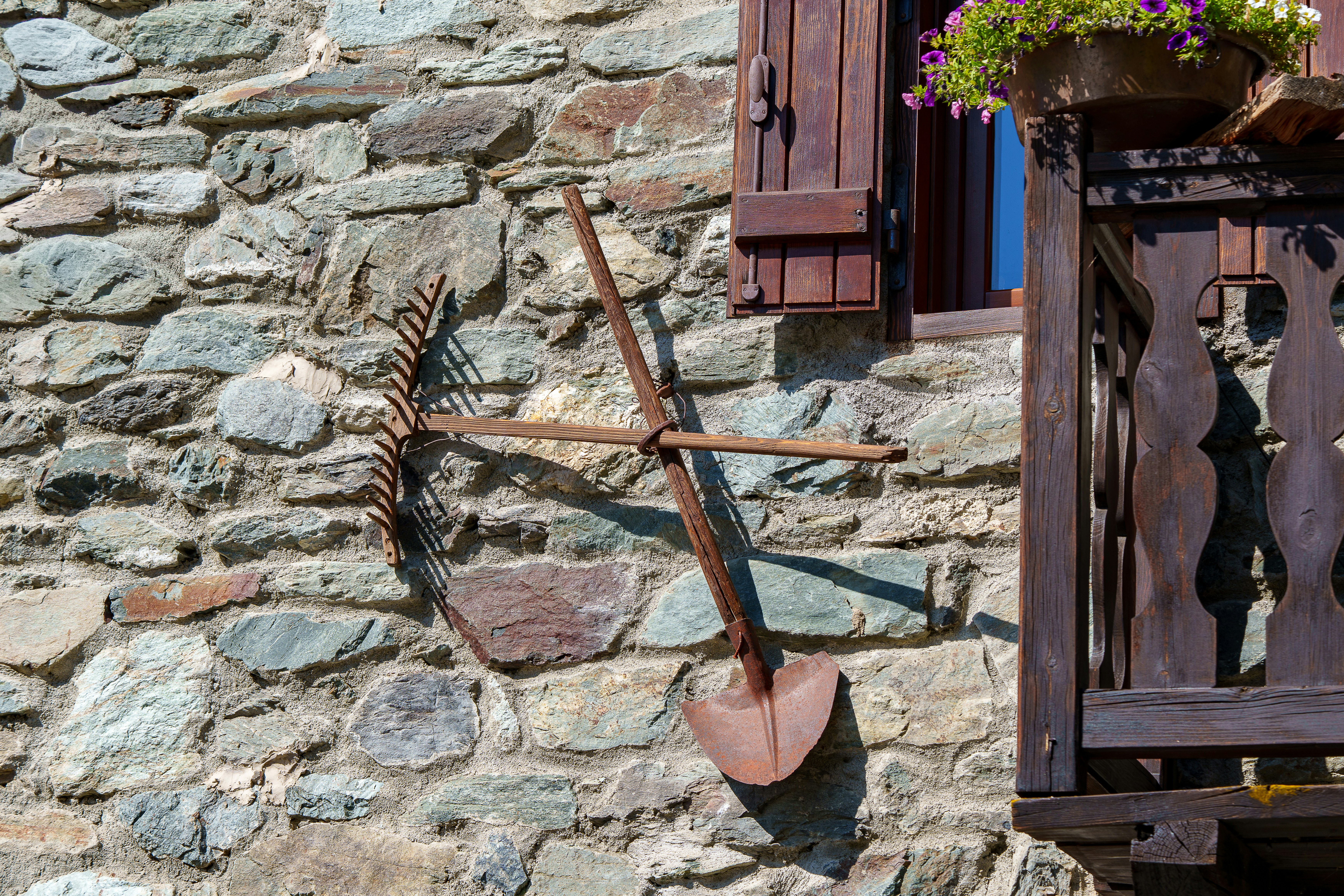 Stone Wall Muse: A Rustic Orchard of Tools by the Balcony