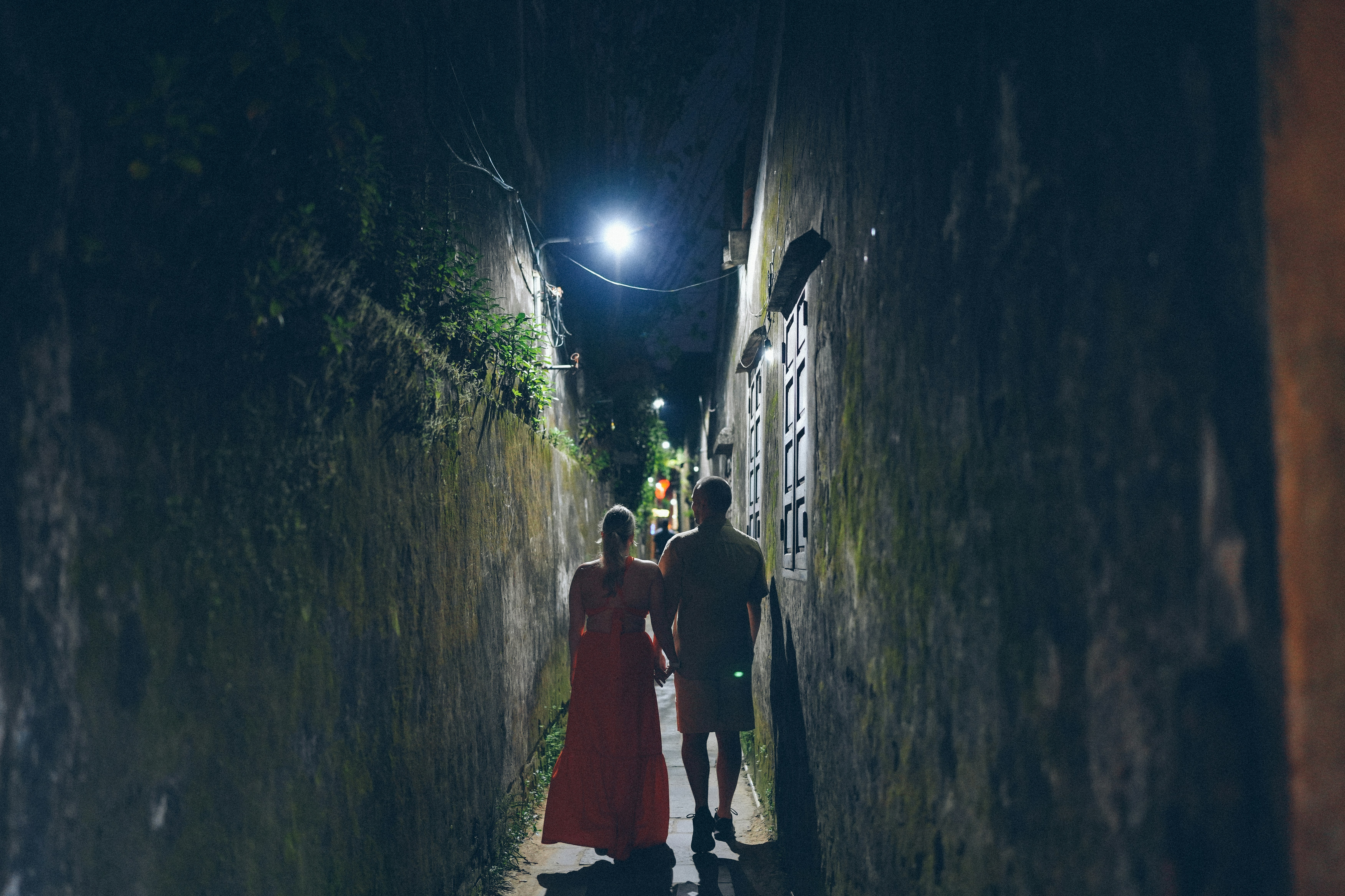 Two Silent Travelers in a Neon-Quiet Alley