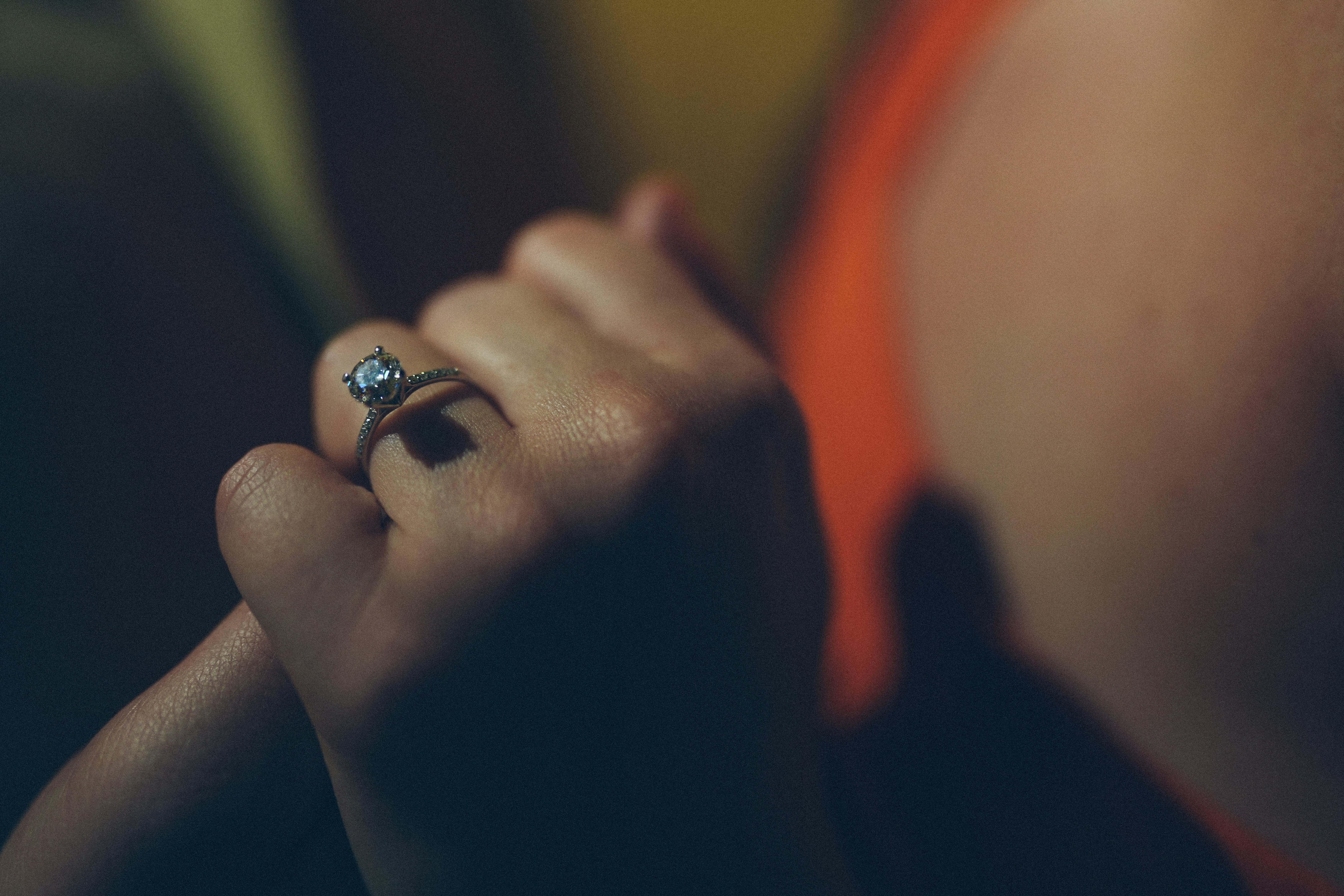 A Quiet Promise: The Glint of a Ring in Dim Light