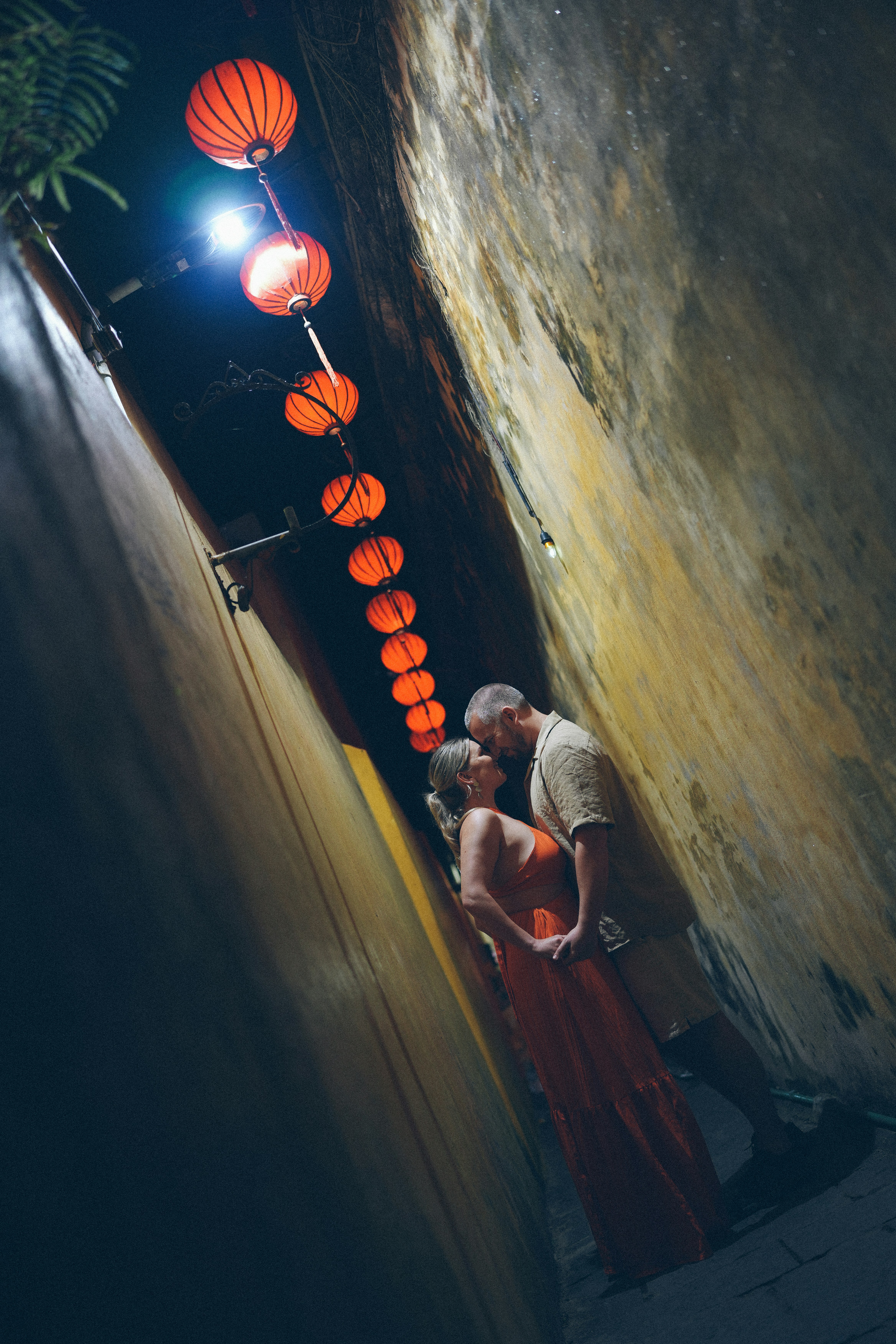 Lantern-lit Embrace in a Narrow Corridor