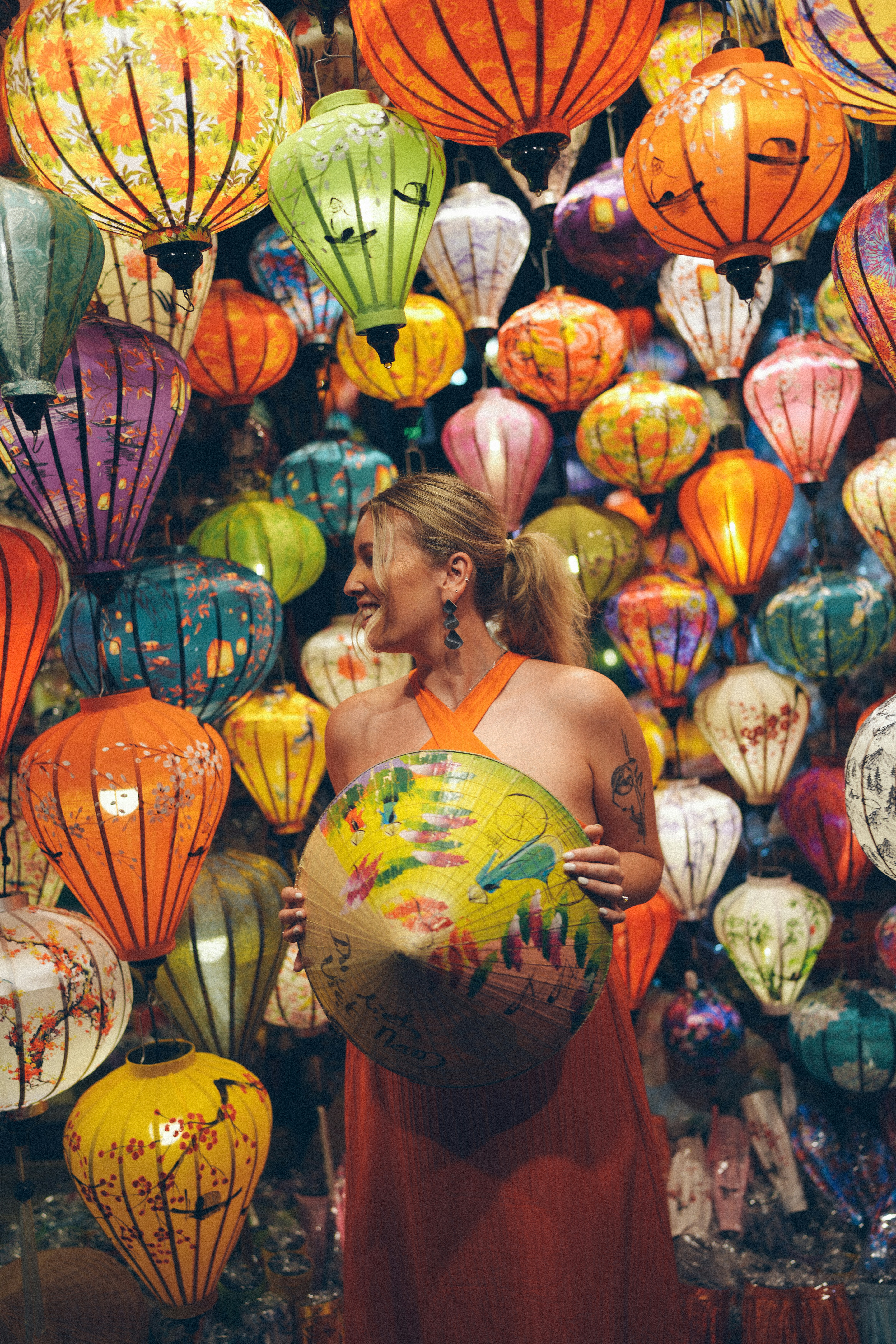 Colorful Lanterns and a Smile: A Moment Beneath the Sky of Orbs