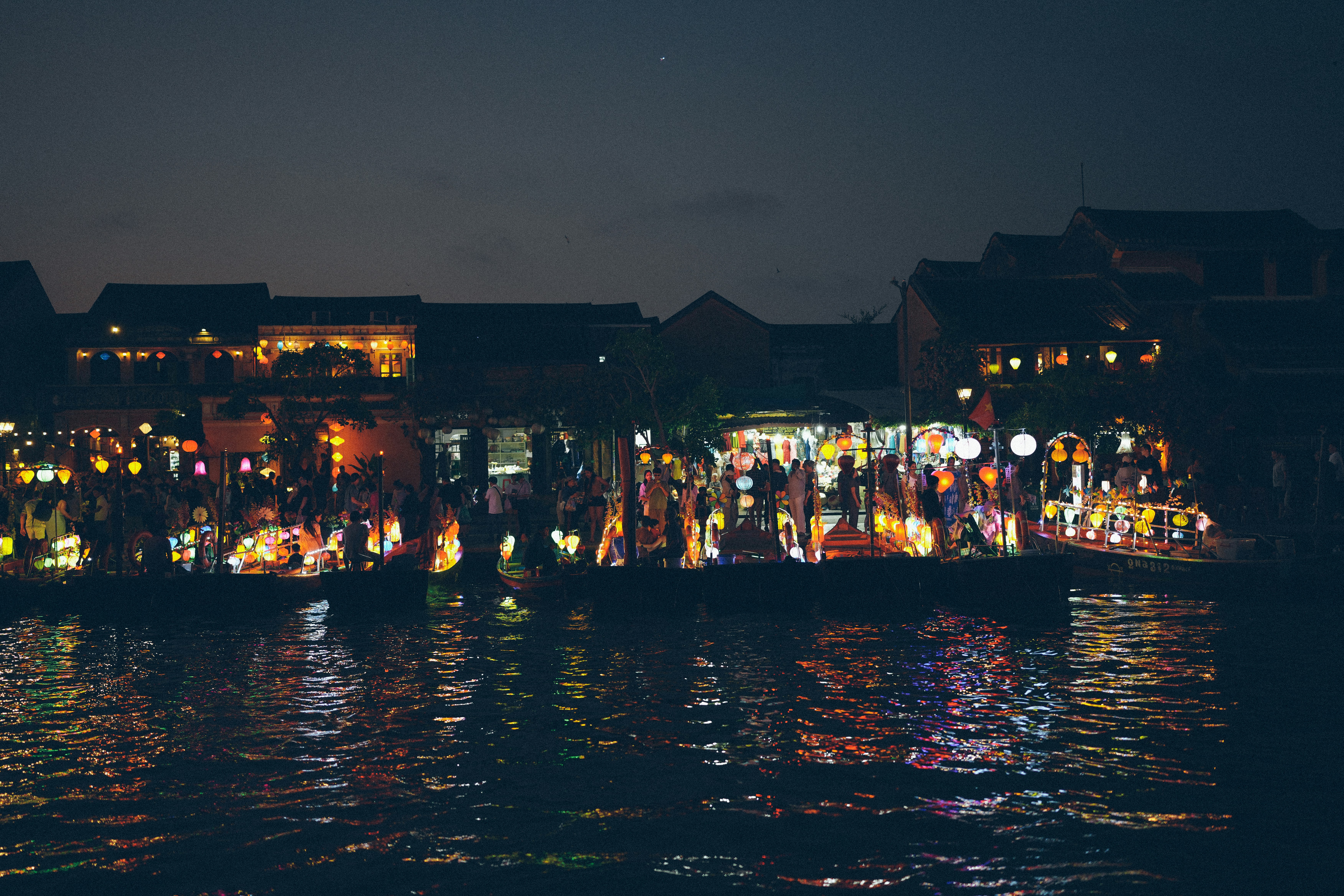 Night Market on the River: Warm Glow and Reflections