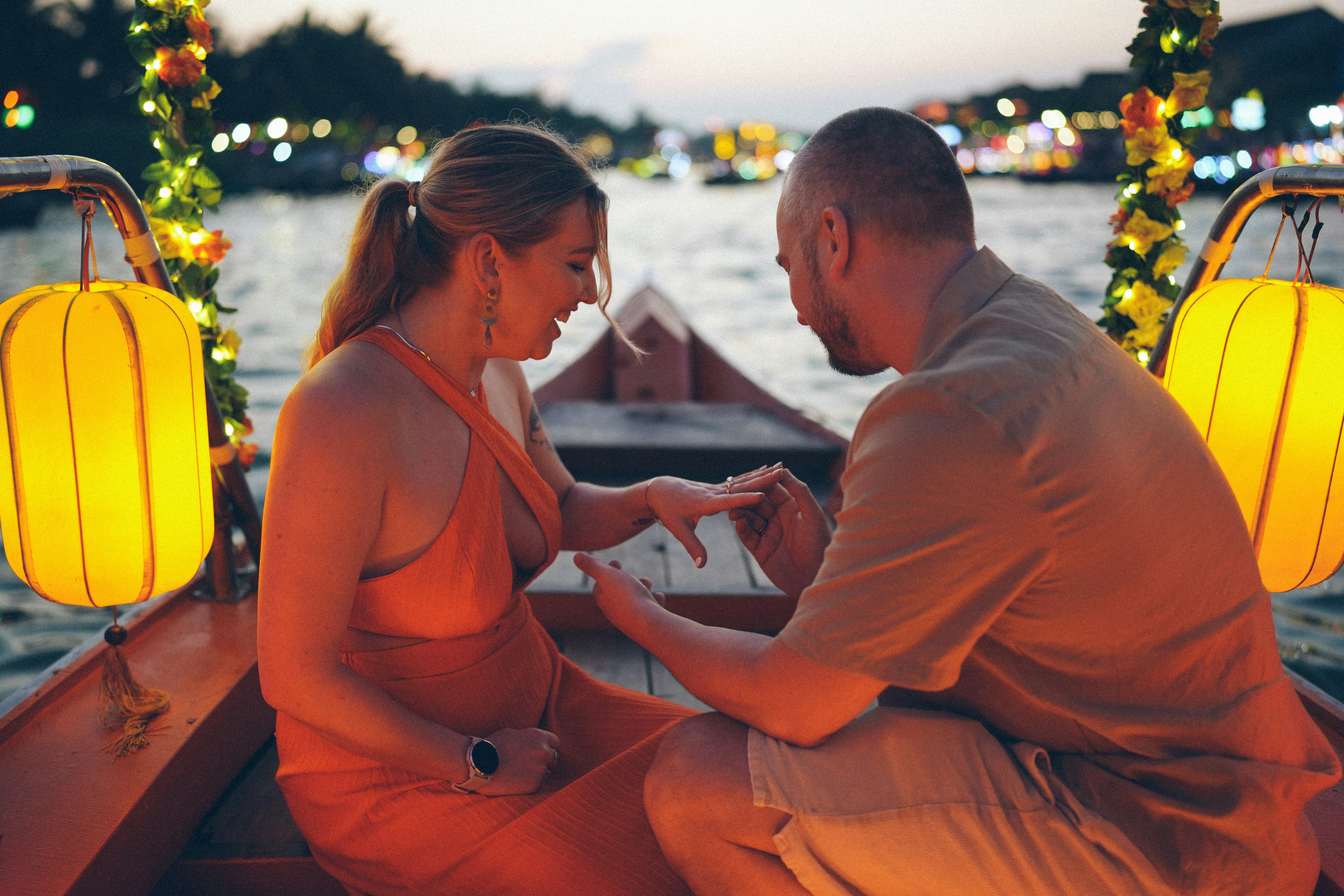 Lantern-lit Moment: A Couple Adorns a Boat with Firelight Gentleness