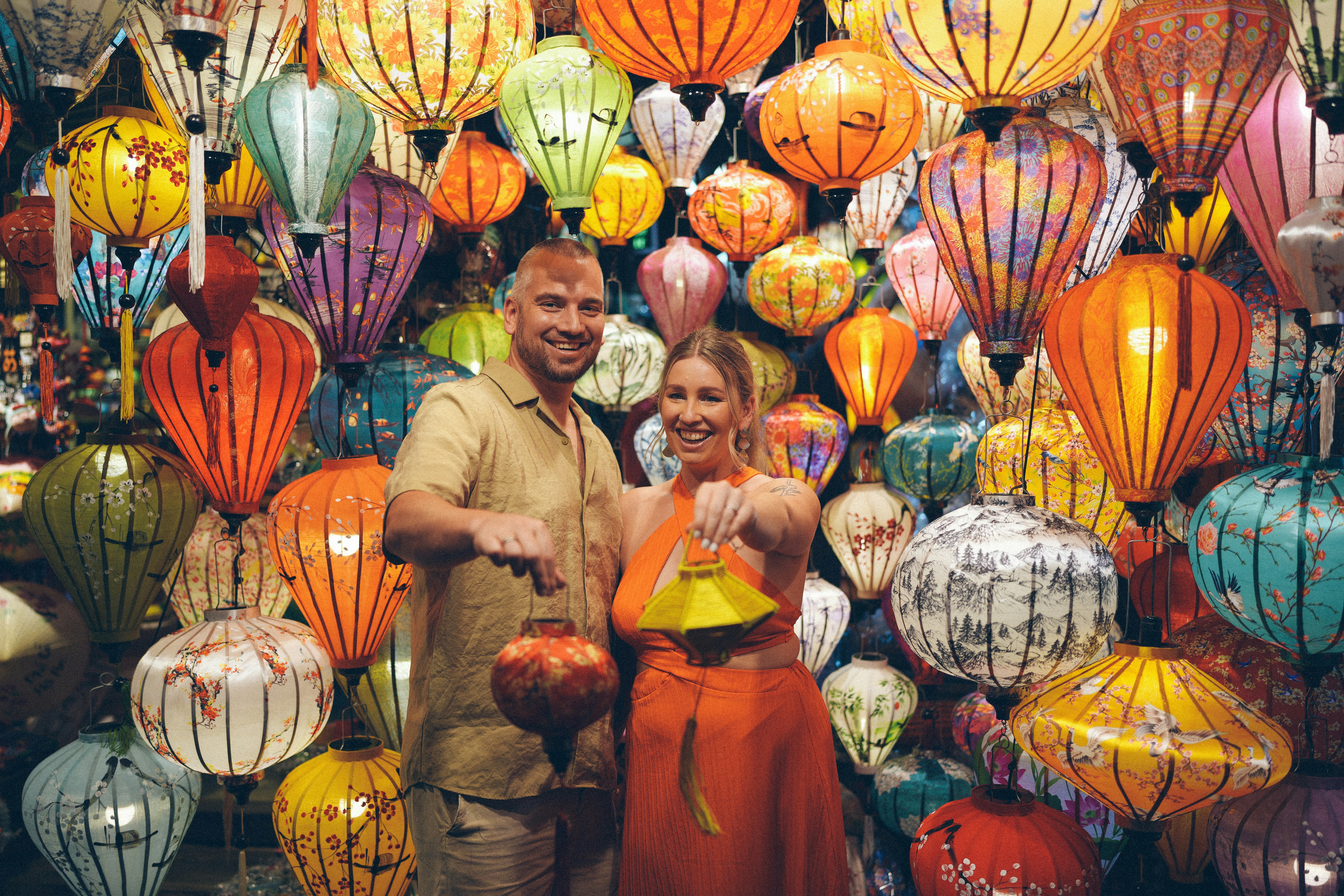 Colorful Lanterns, Joyful Duo: A Moment Under Light-filled Orbs