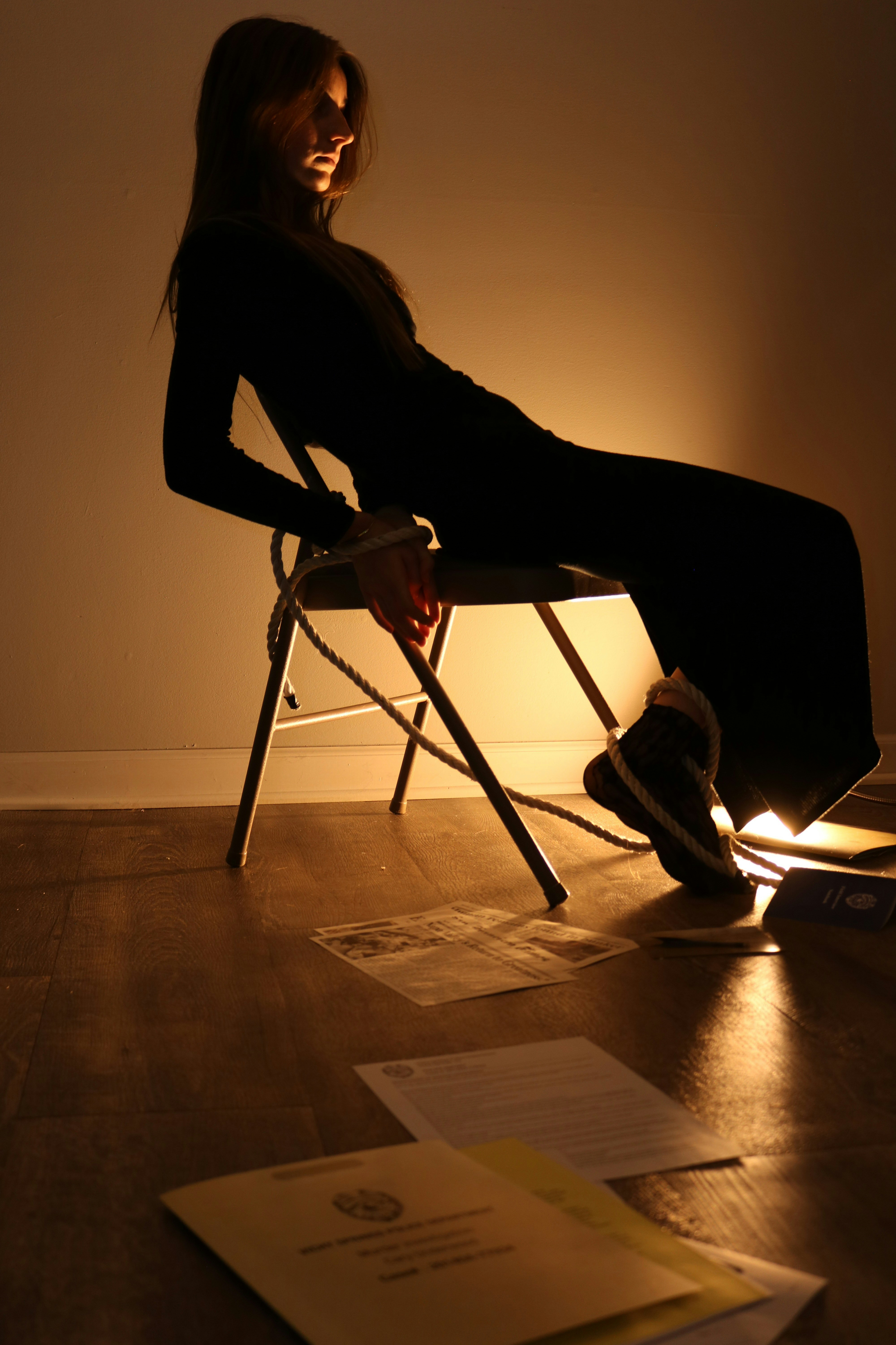 Woman tied to chair with papers on floor photo – Free Chair Image on ...