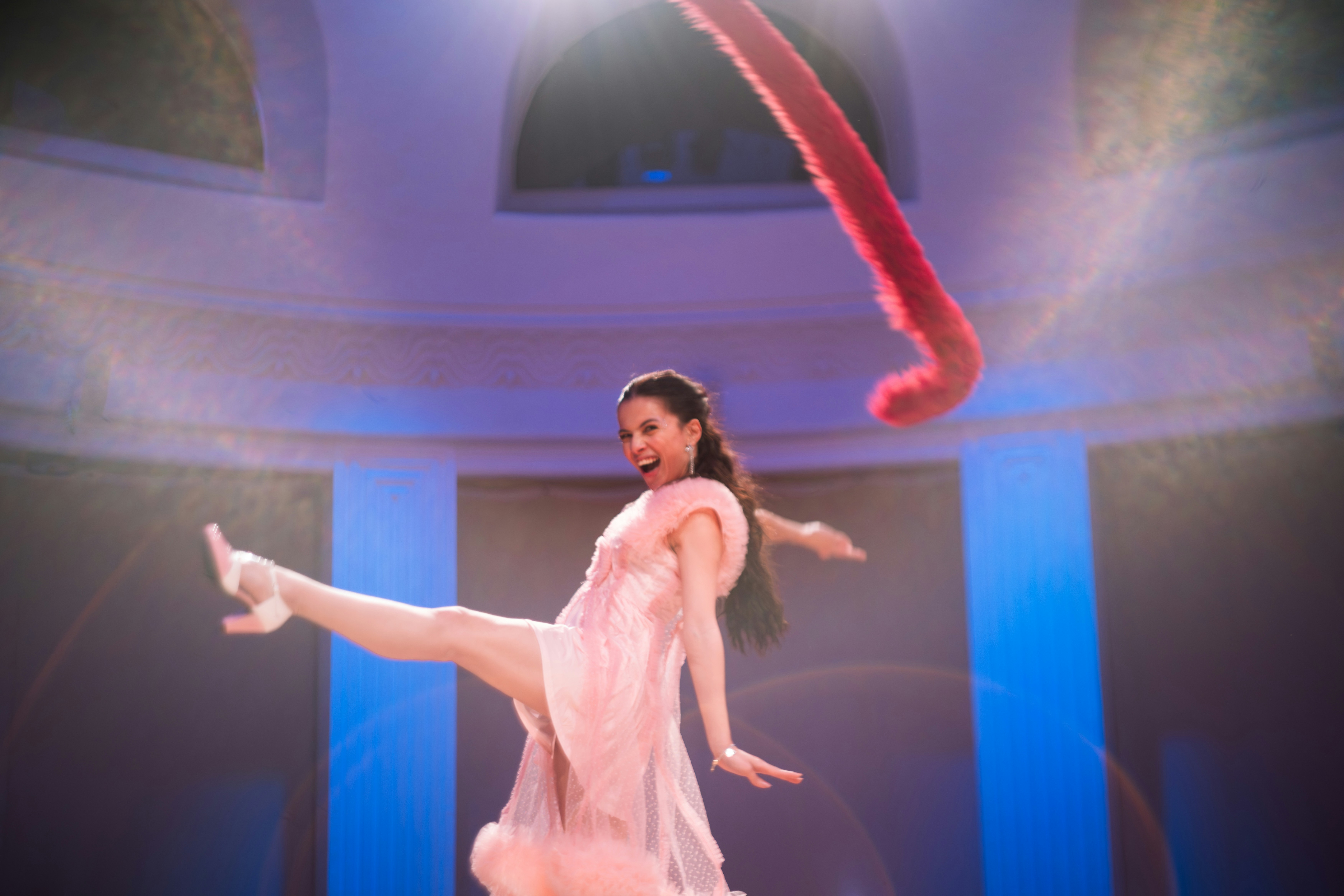 Grace in Motion: A Silk-draped Performance Under Velvet Blue Lights