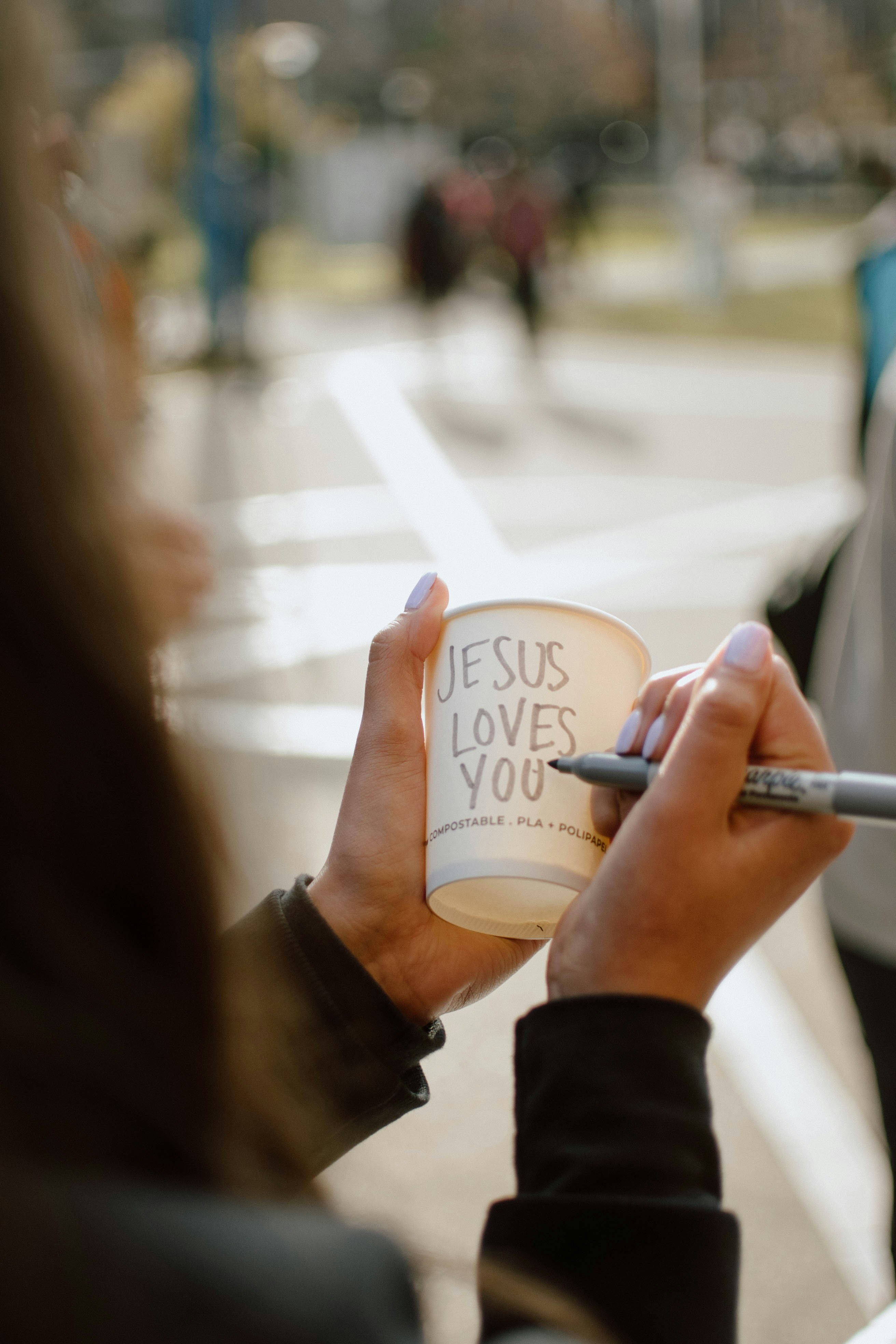 Cup of Courage: A handwritten message in a busy street scene