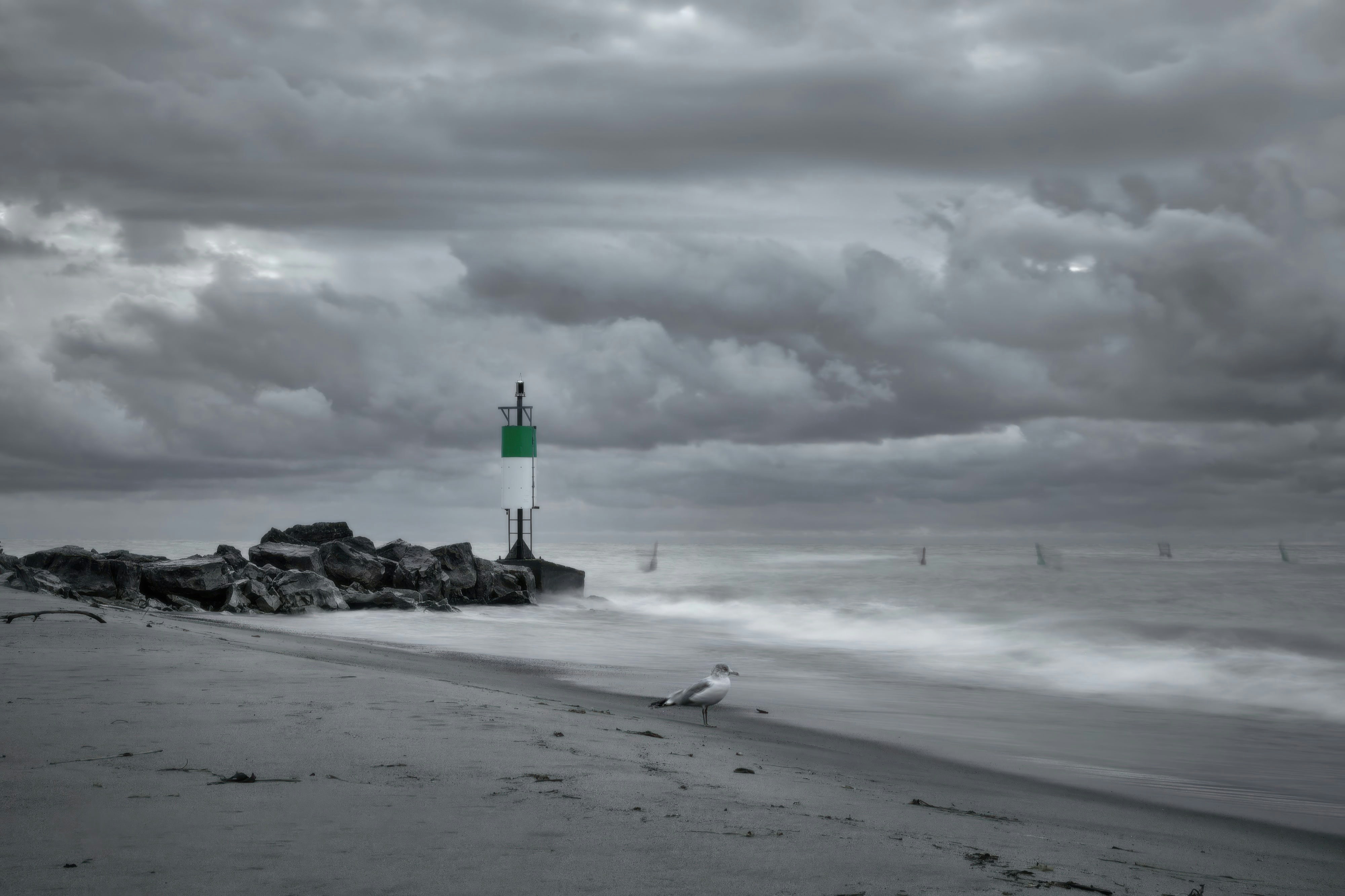 Storm-Burnished Ledge: A Quiet Lighthouse Speck in Twilight
