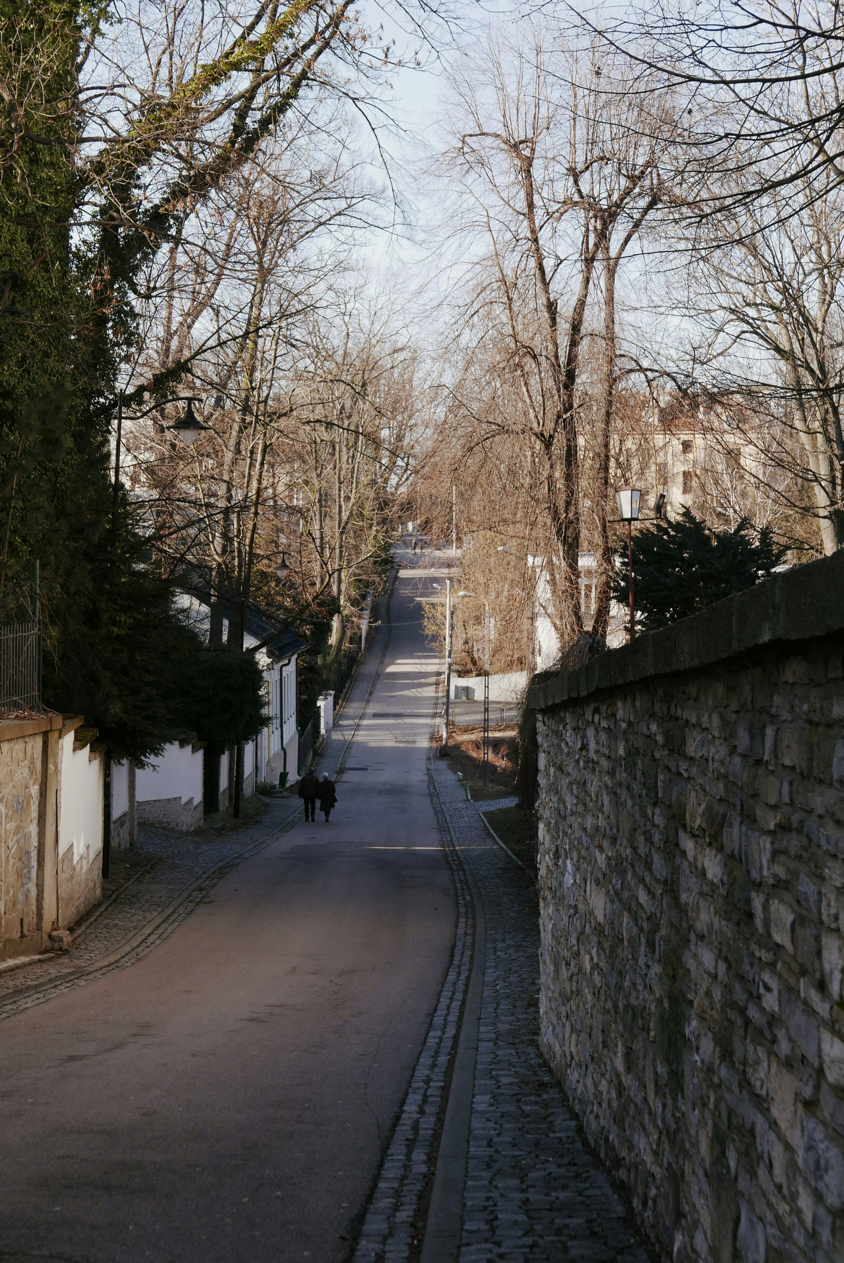 A Quiet Descent: Winter Street Between Timeworn Walls