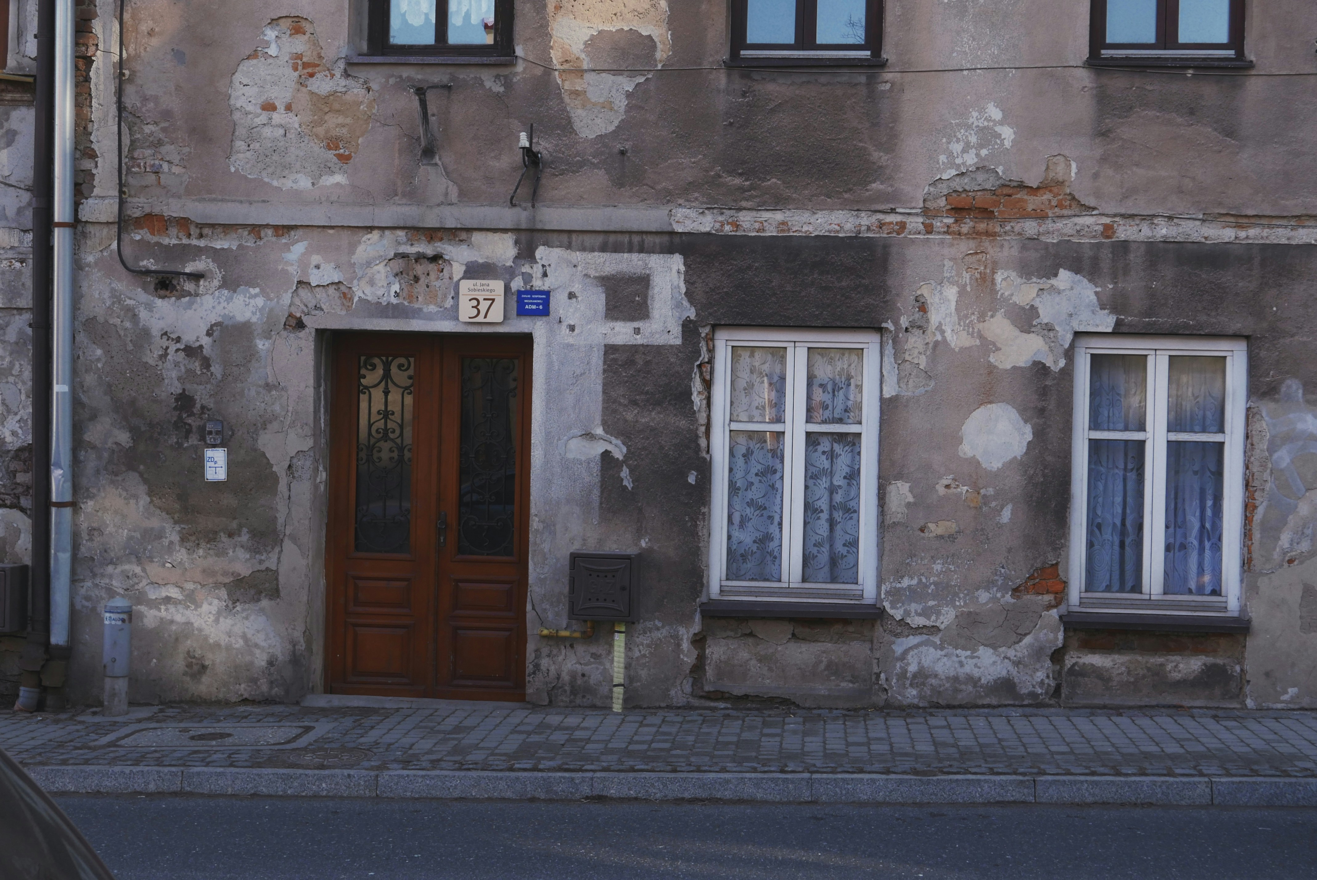Weathered doorway under patchwork plaster on a European building