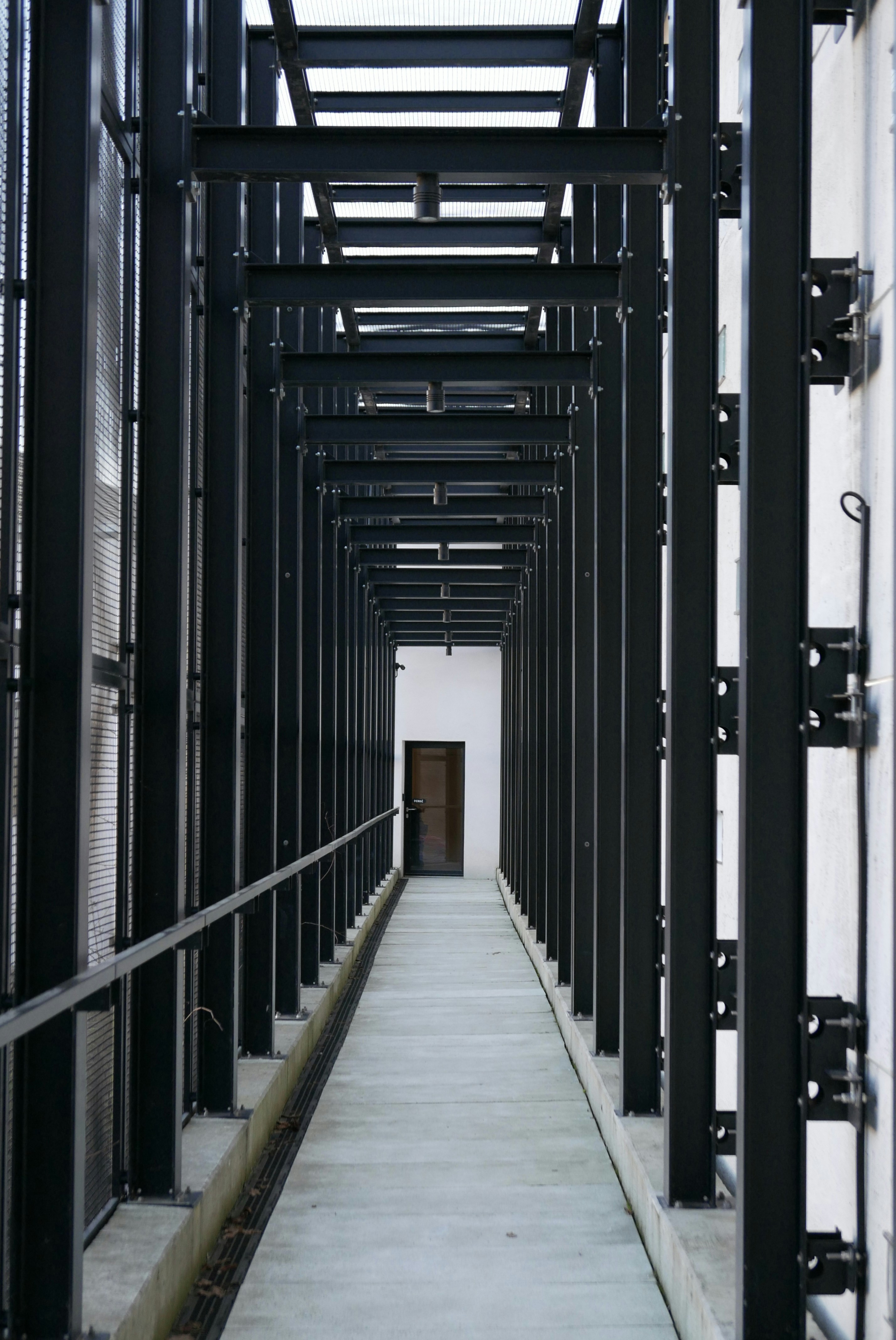 Architectural Corridor: Infinite Steel Framing Receding to a Door
