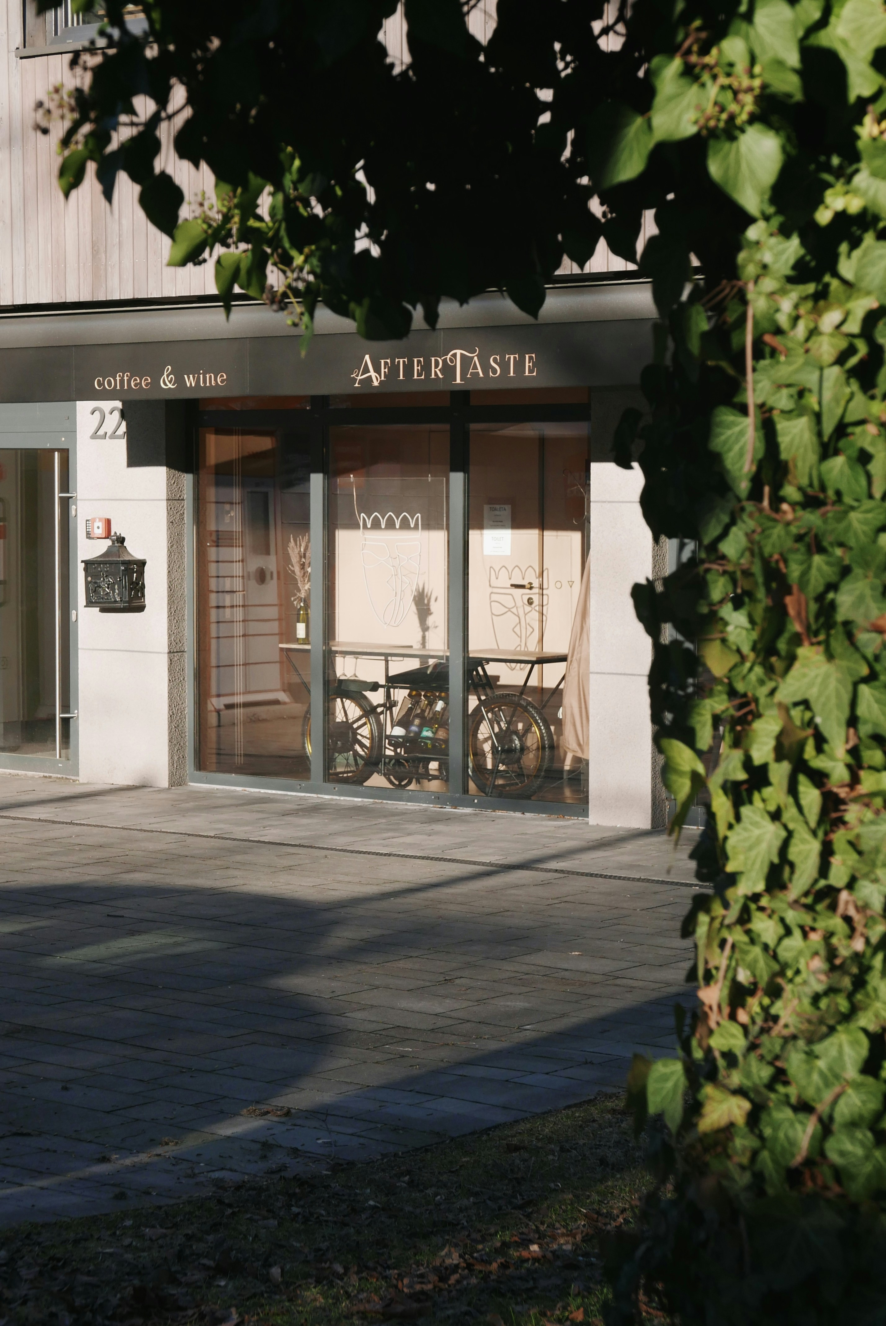 AfterTaste Café Window with Bicycles as Quiet Centerpiece