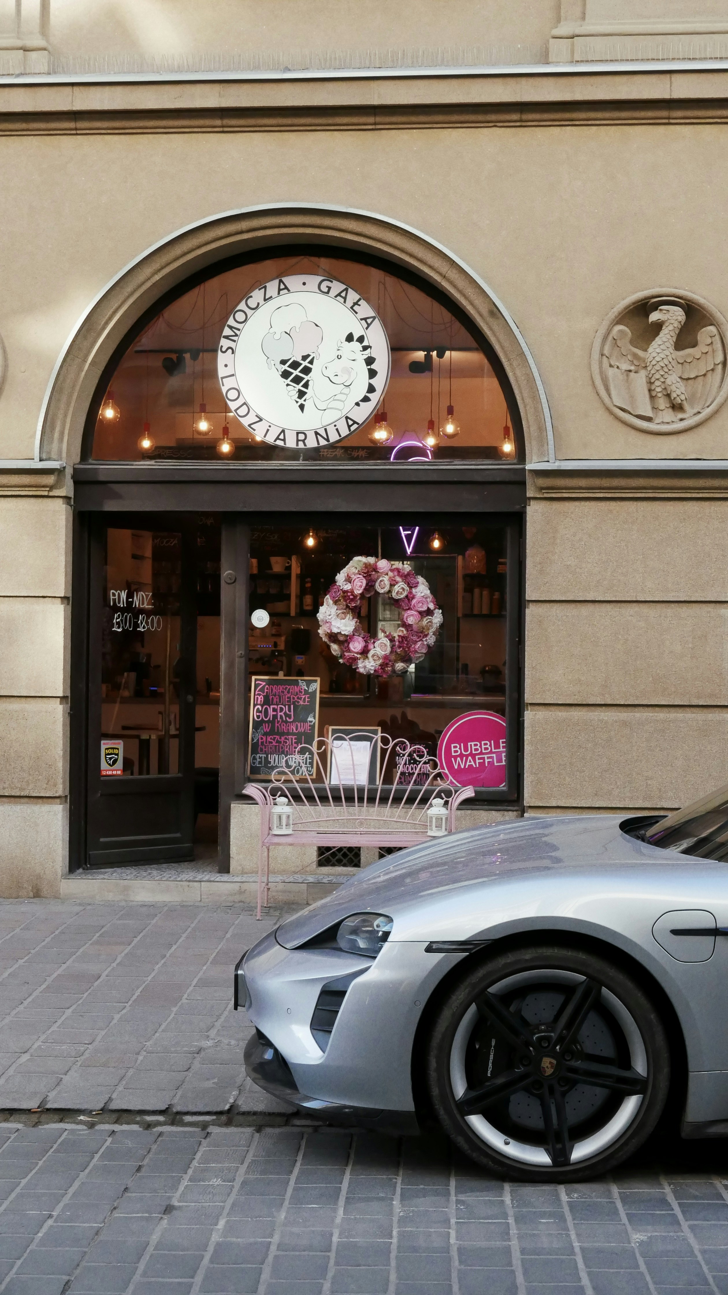 Neon Heart in the Shopfront: A Silver Porsche by the Wreath
