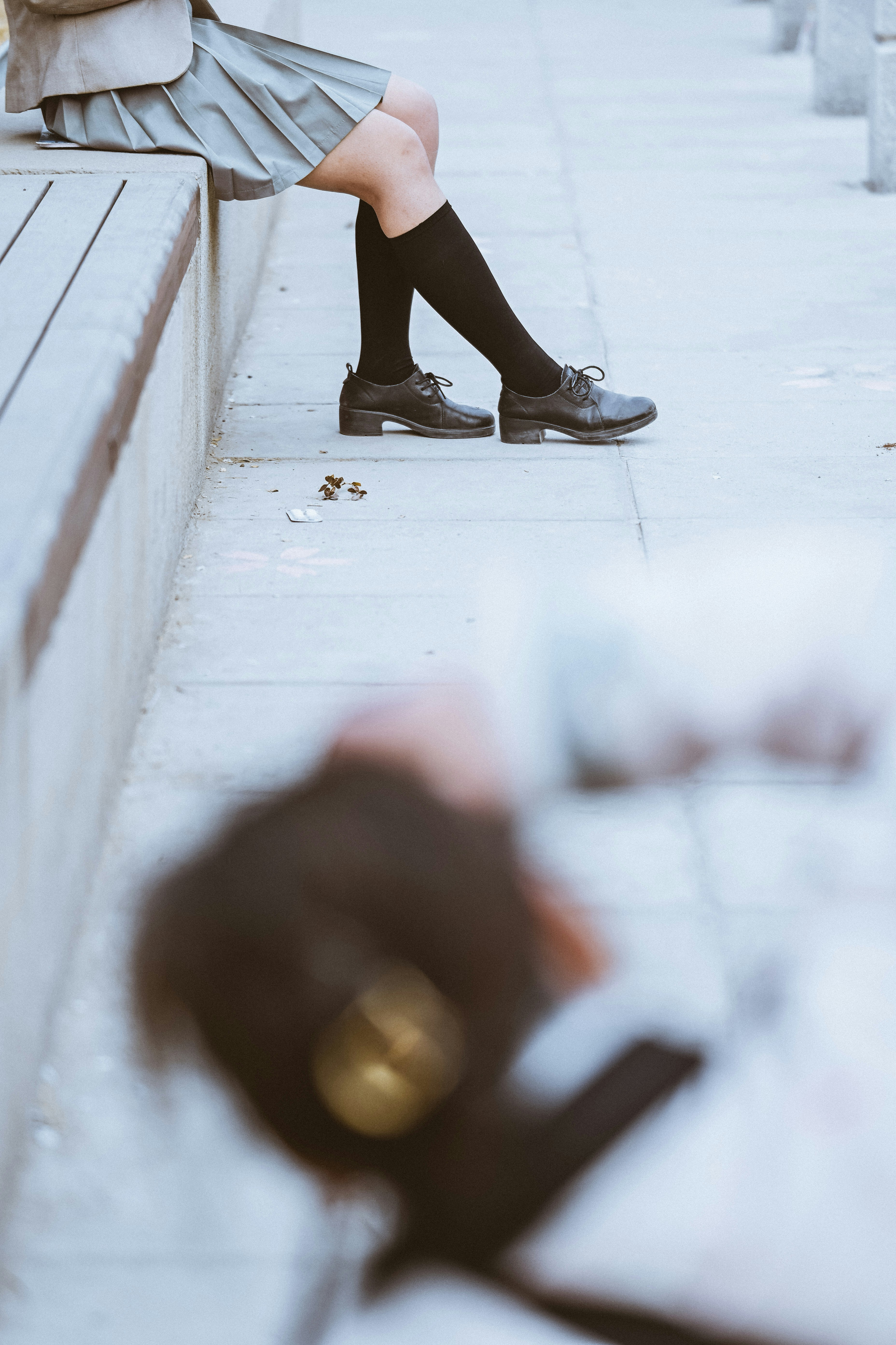 Leggy Quiet: A Student in Focus on a Benched Moment