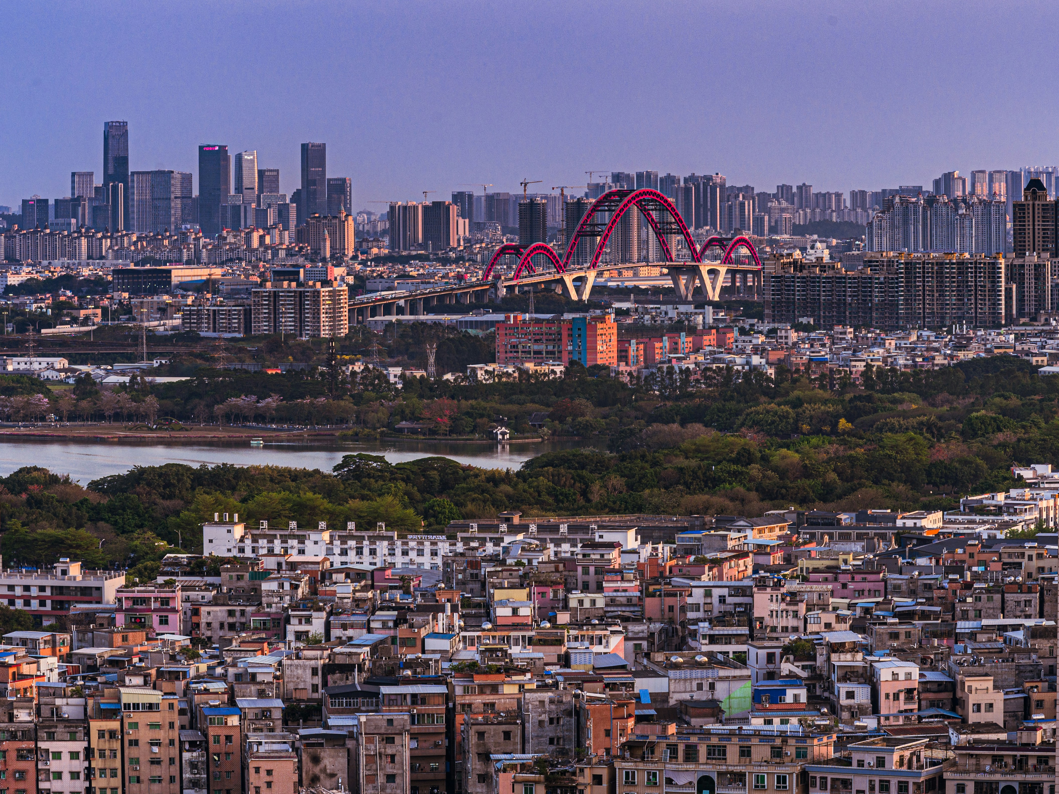 Red Ribbon over the River: A Cityscape Framed by a Golden Bridge