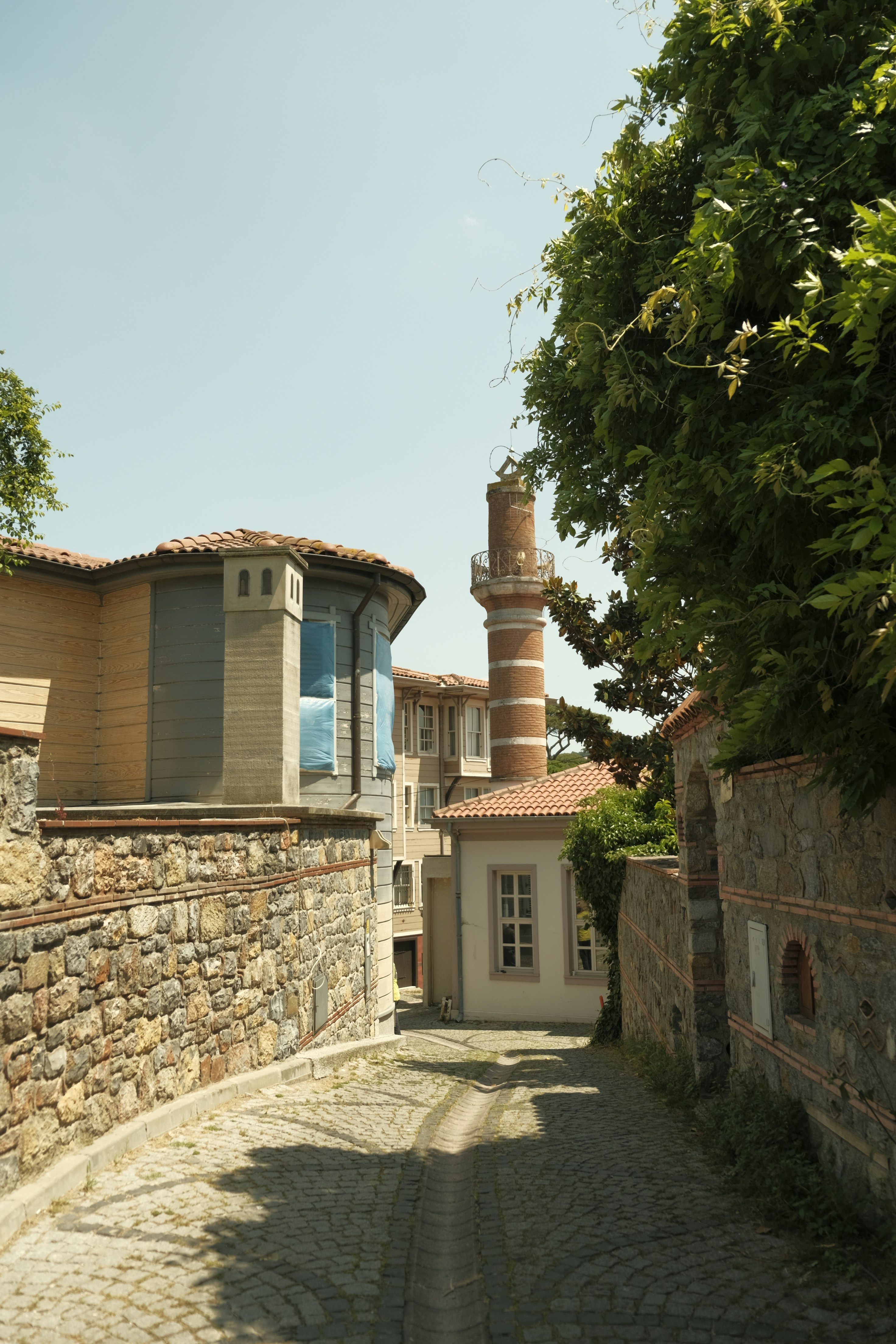 Cobbled Lane to a Quiet Mast with Sunlit Facades